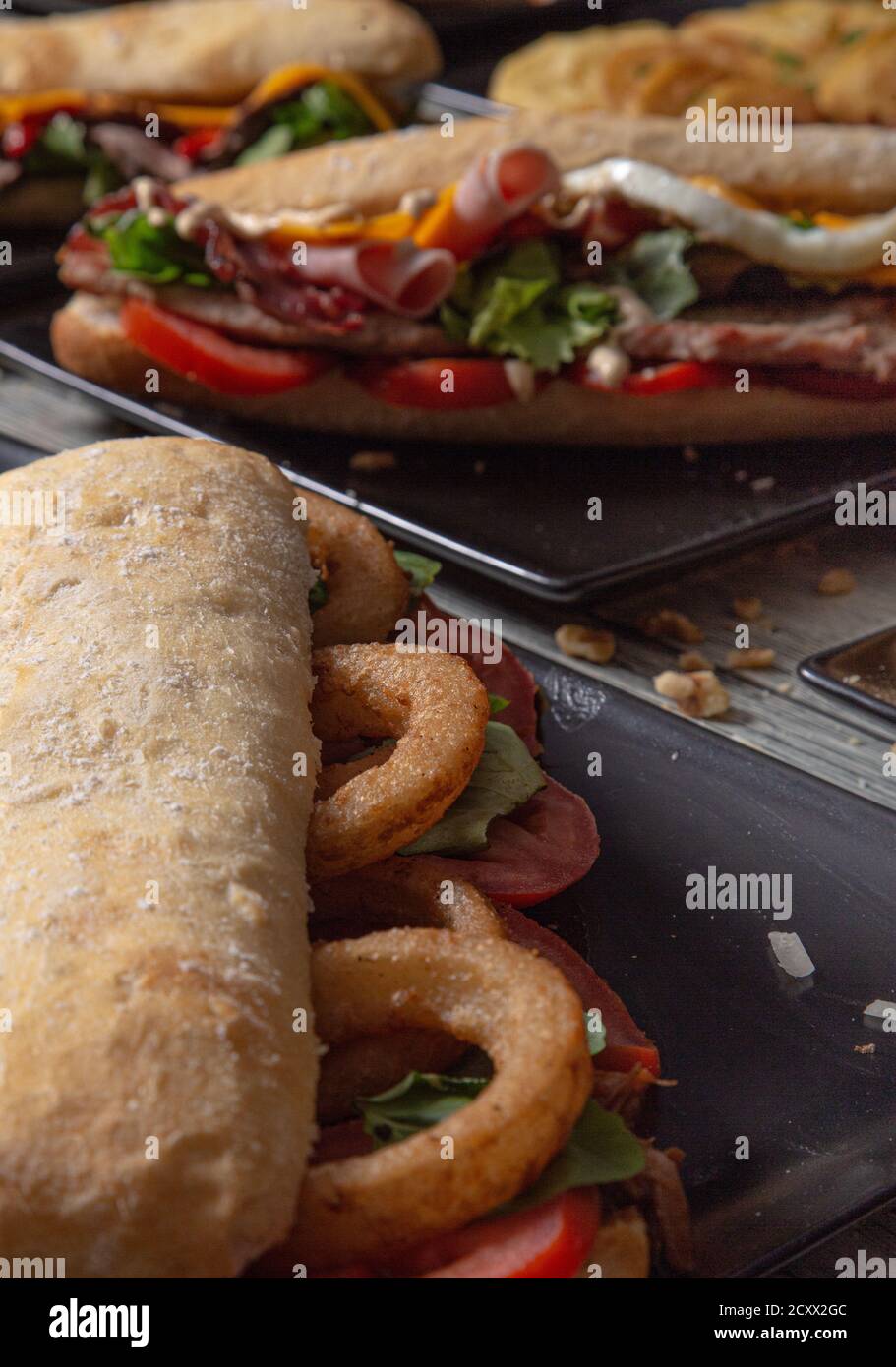 closed image of sandwiches on wooden table with various ingredients and ...