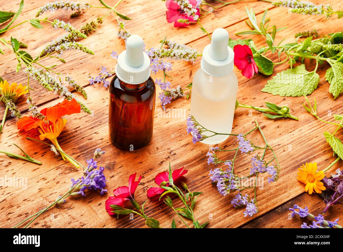 Bottles of tincture and healthy herbs and flowers.Alternative healthy ...
