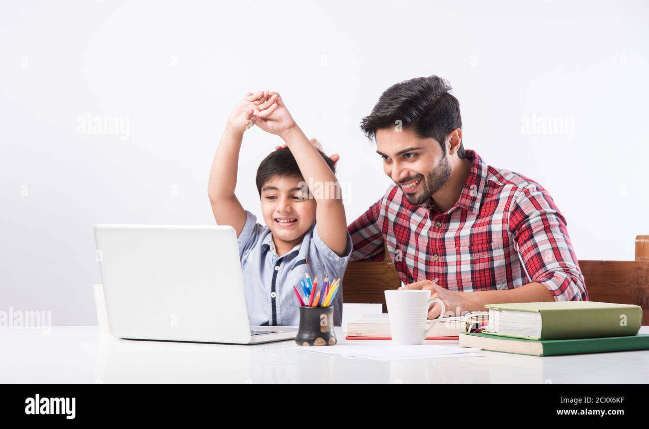 Indian kid doing homework computer hi-res stock photography and images ...