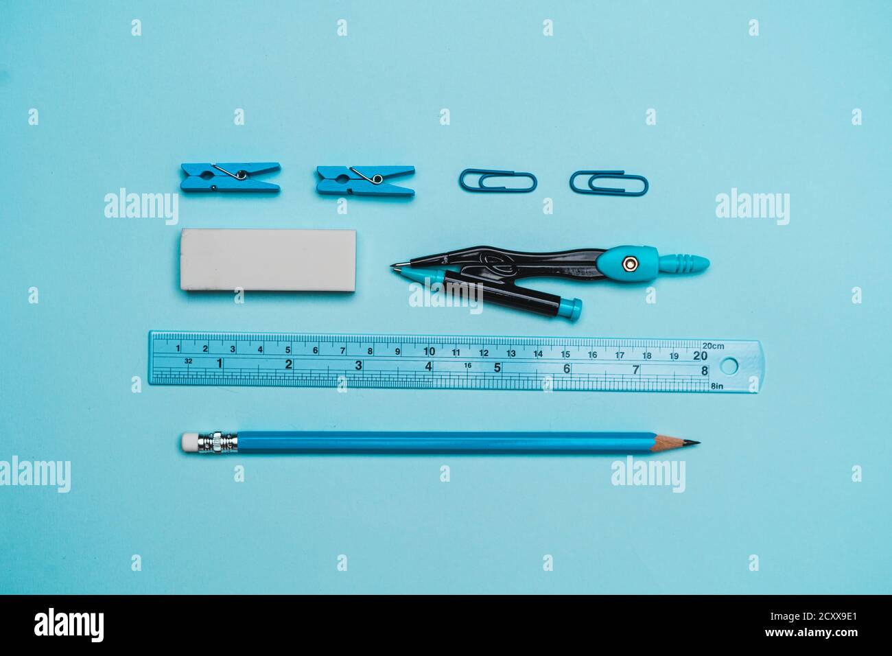 Stationery - book, pencil, ruler on a blue background Stock Photo - Alamy