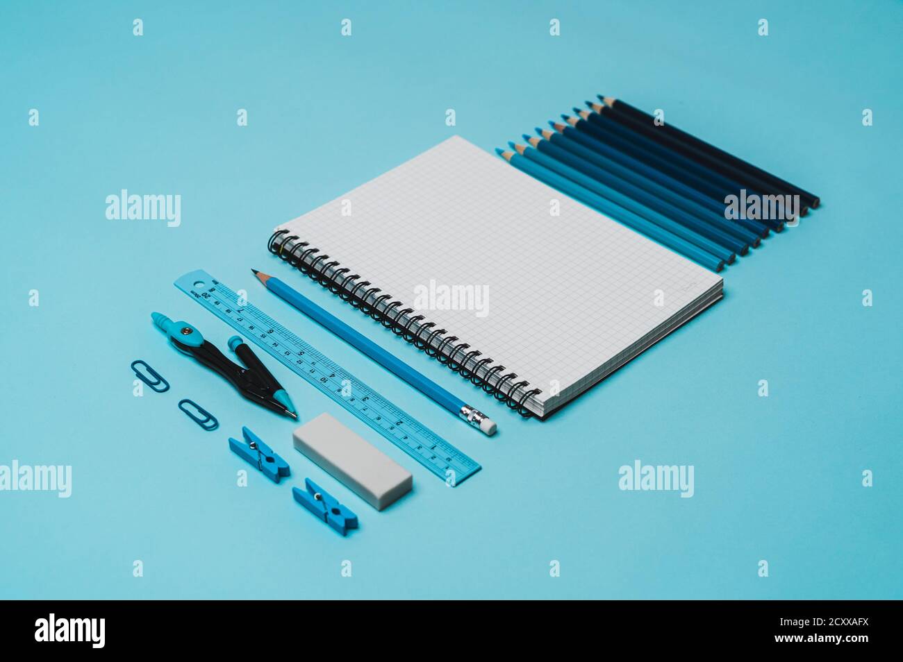 Stationery - book, pencil, ruler on a blue background Stock Photo - Alamy