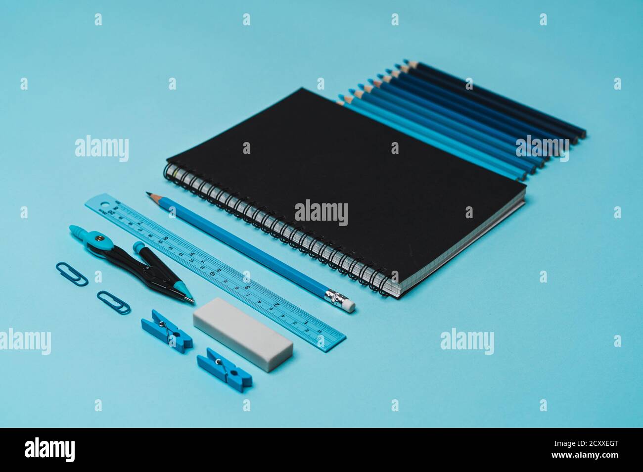 Stationery - book, pencil, ruler on a blue background Stock Photo - Alamy