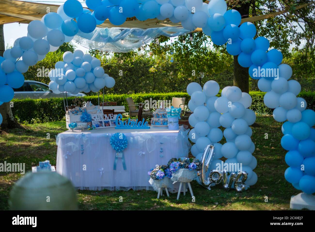 set up for baby baptism with puppets and blue balloons. High quality ...