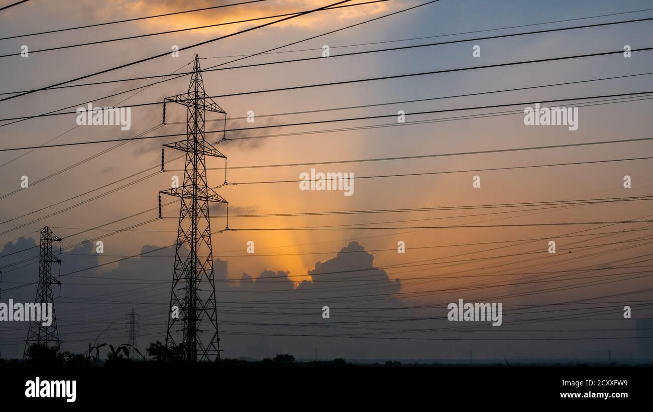 High-voltage power lines at Sunrise/sunset. electricity distribution ...