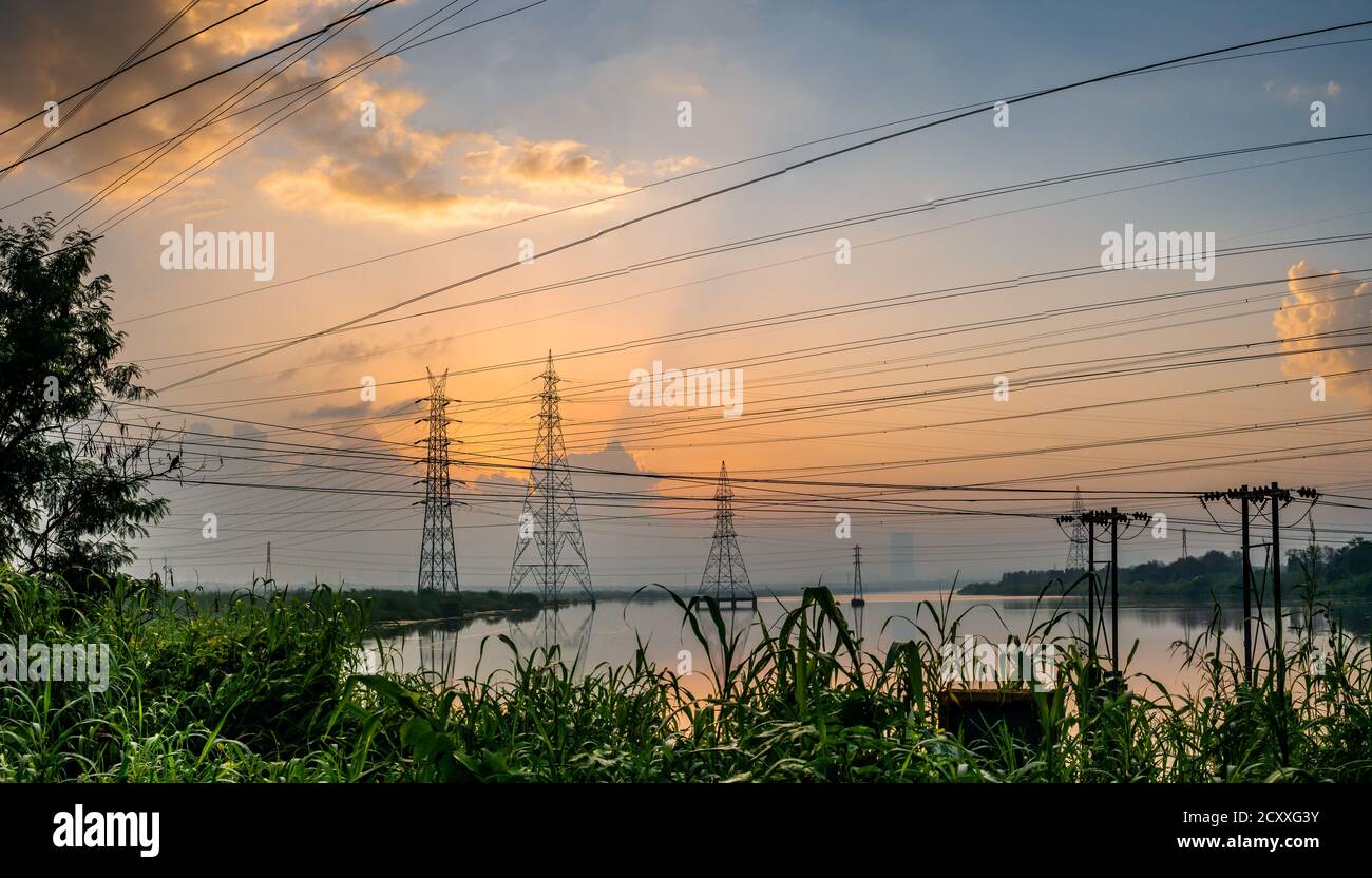 High-voltage power lines at Sunrise/sunset. electricity distribution ...