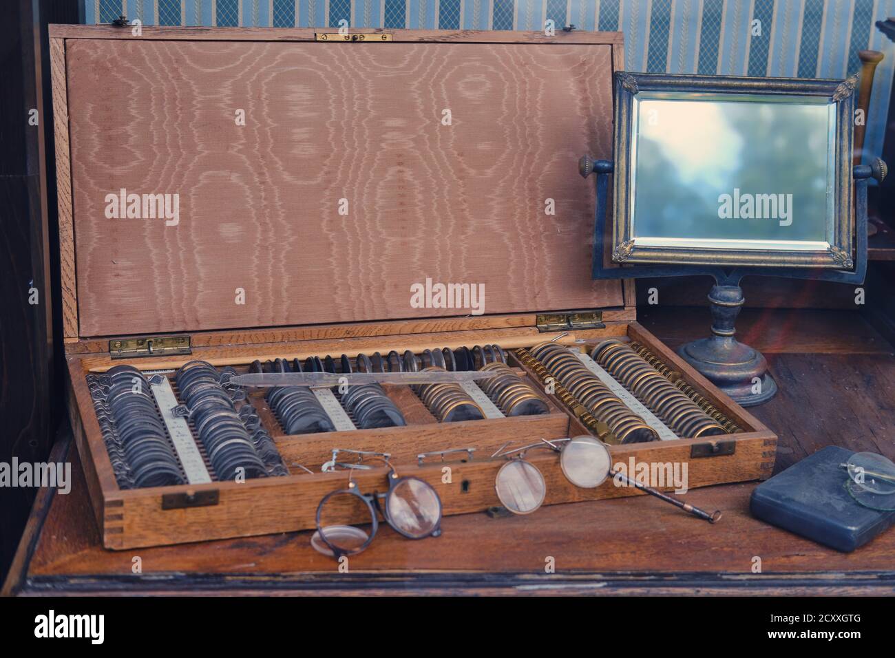 Vintage ophthalmologist medical instruments with mirror and glasses ...