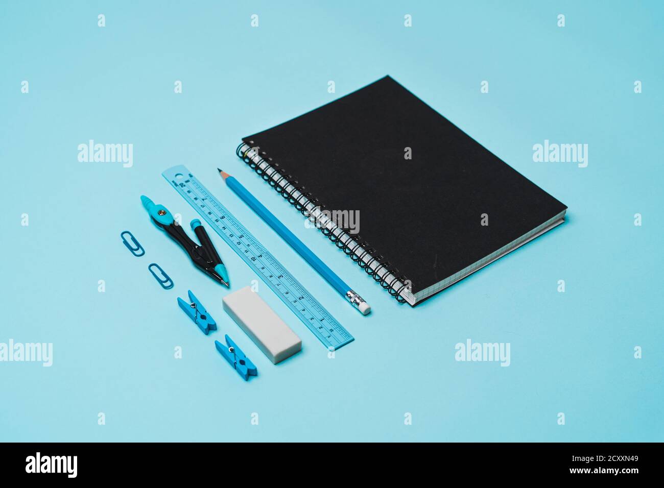 Stationery - book, pencil, ruler on a blue background Stock Photo - Alamy