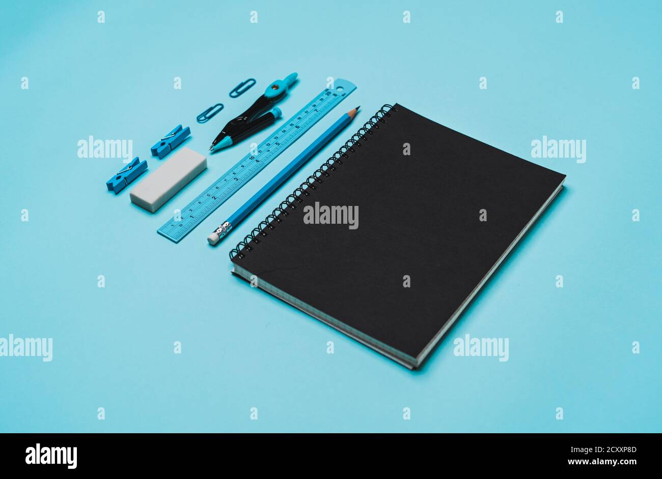 Stationery - book, pencil, ruler on a blue background Stock Photo - Alamy