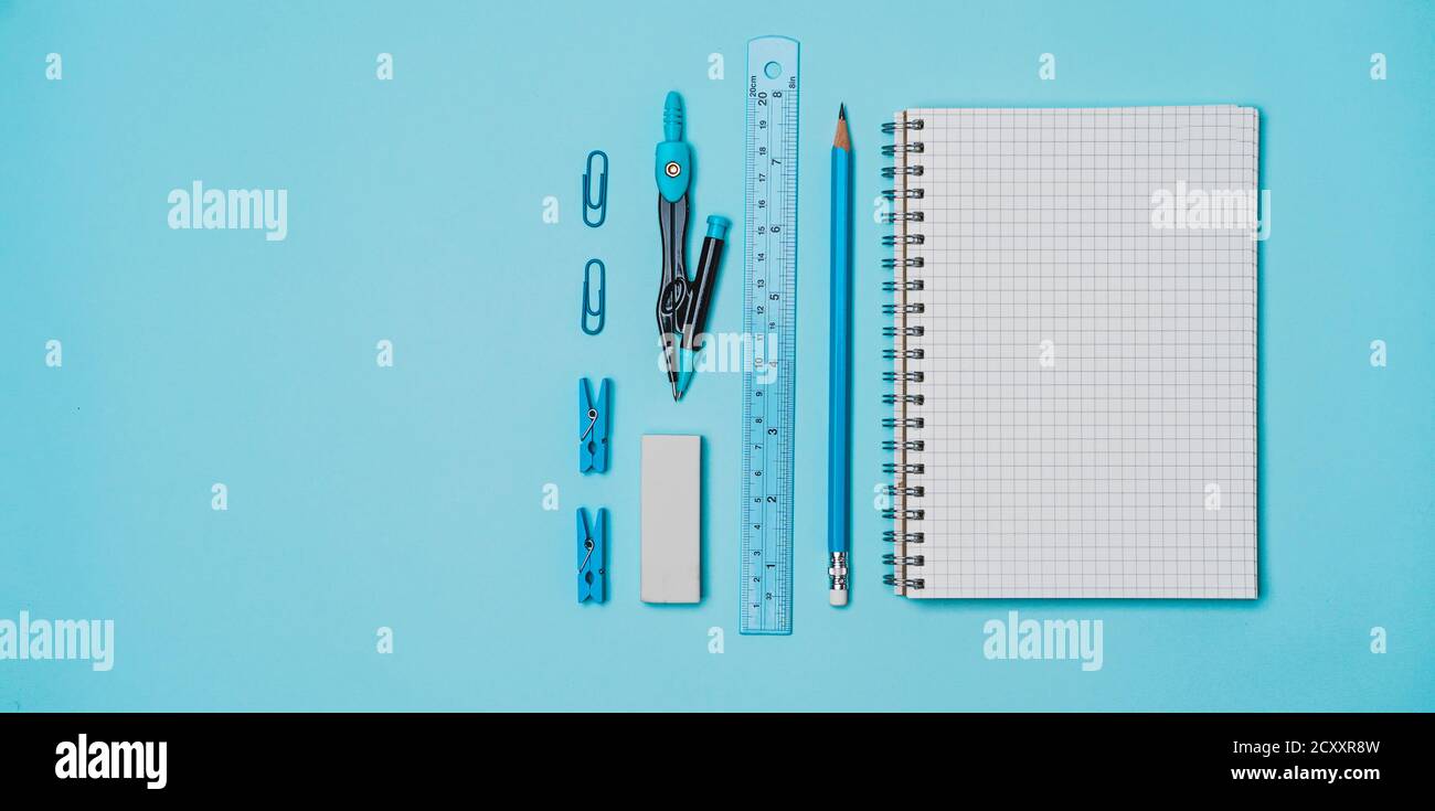 Stationery - book, pencil, ruler on a blue background Stock Photo - Alamy