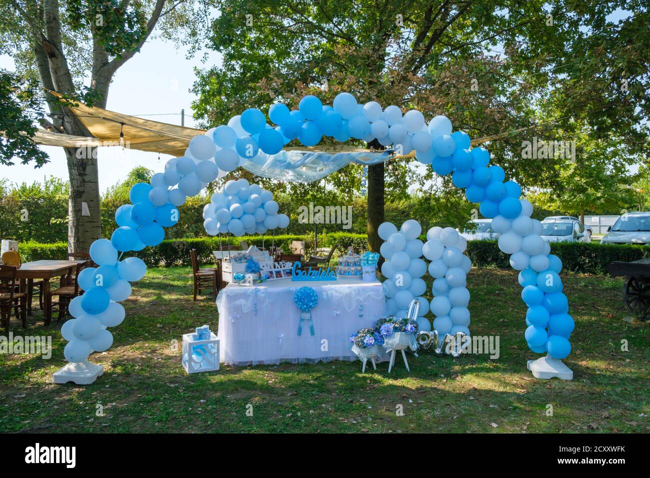 set up for baby baptism with puppets and blue balloons. High quality ...