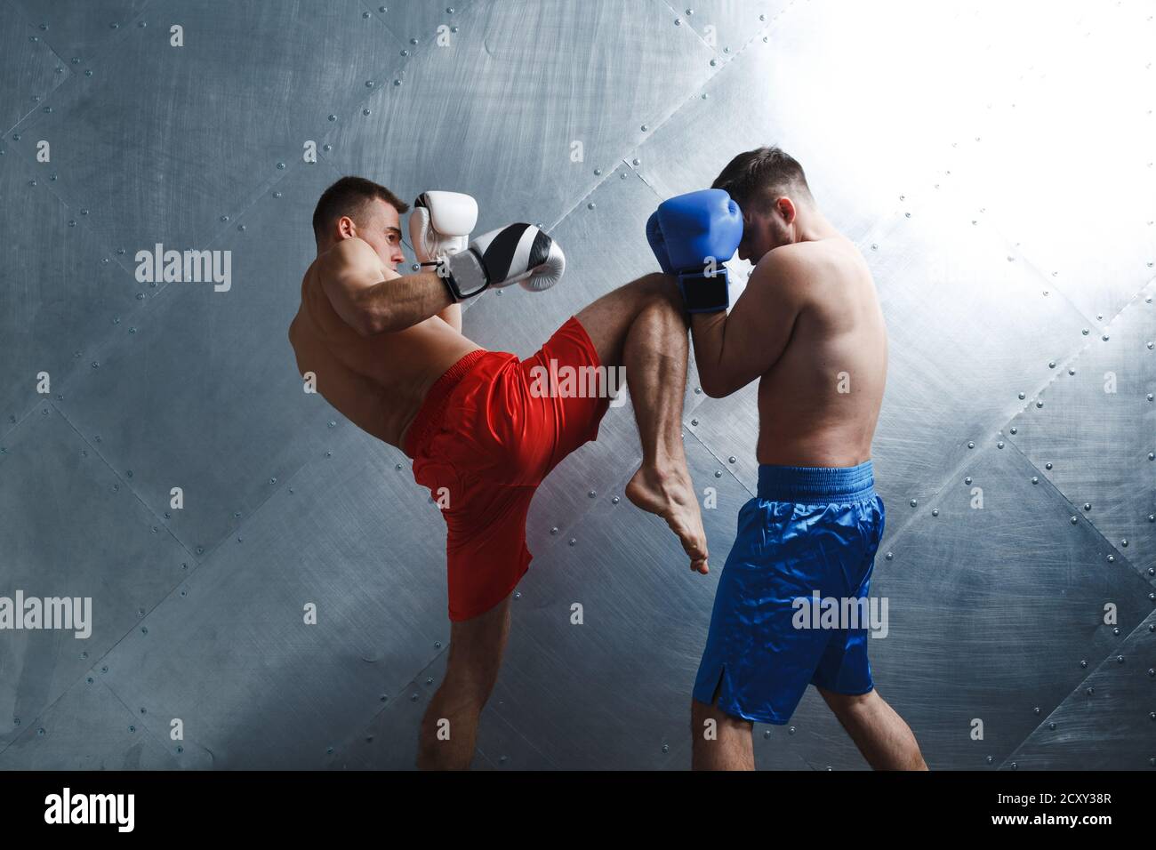 Two men boxers fighting muay thai boxing Stock Photo - Alamy