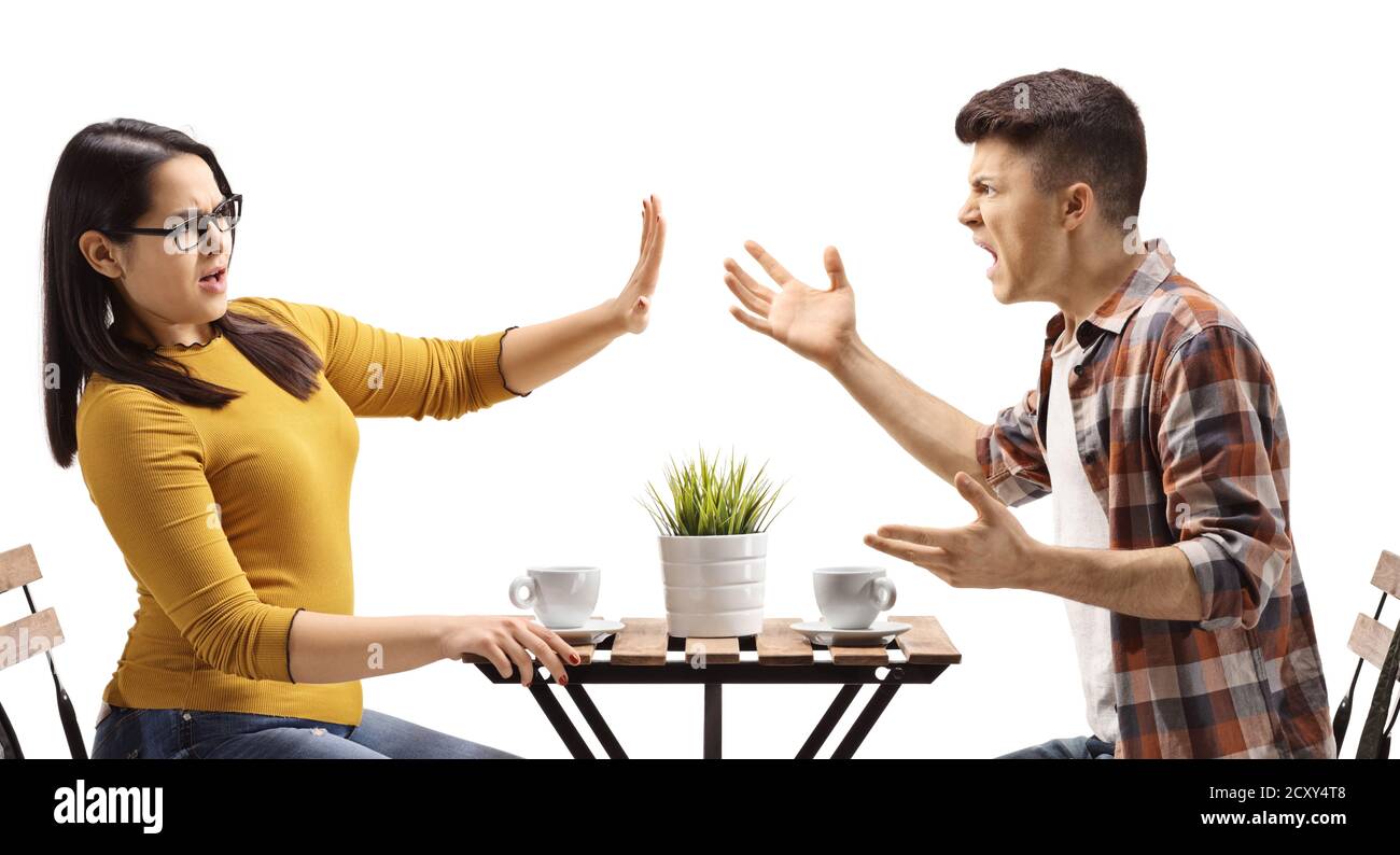 Young man and woman arguing in a cafe isolated on white background ...