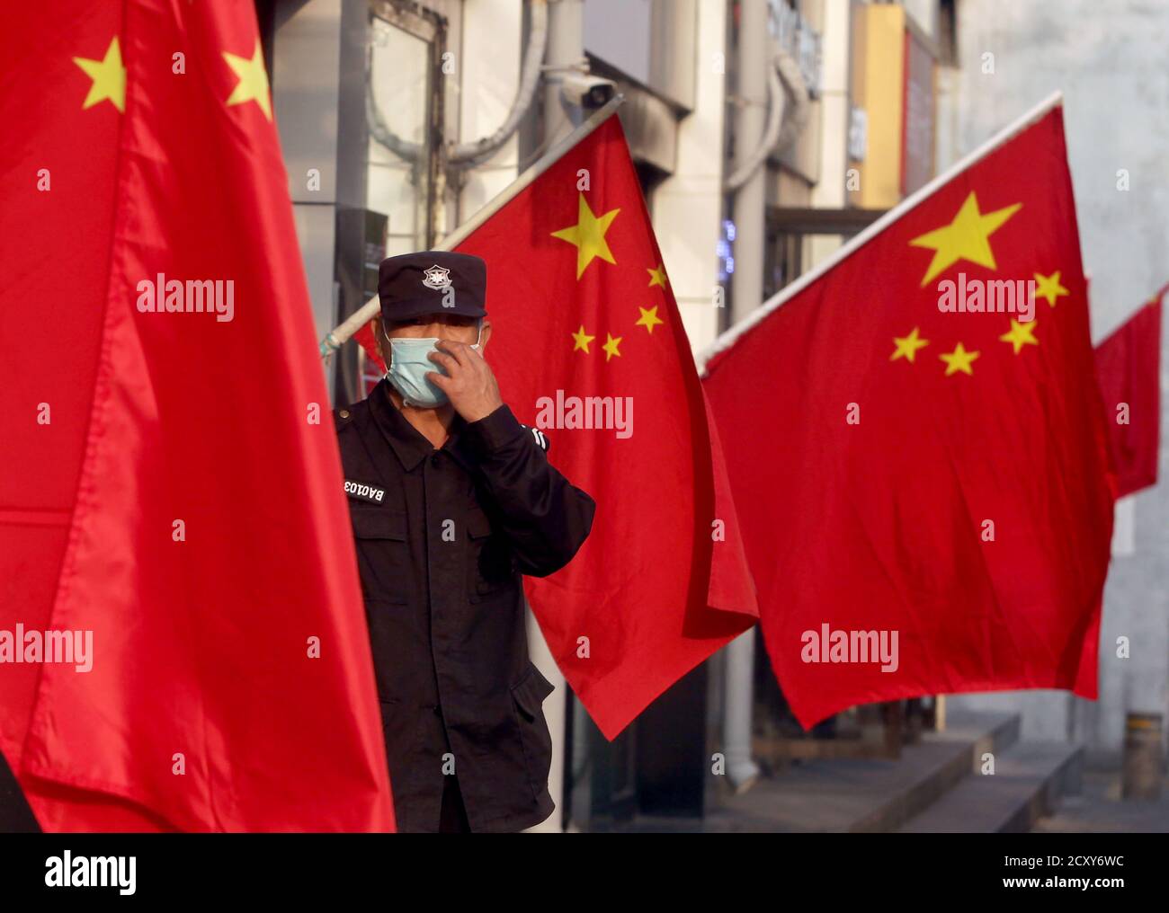 Beijing, China. 01st Oct, 2020. A Chinese security guard watches as ...
