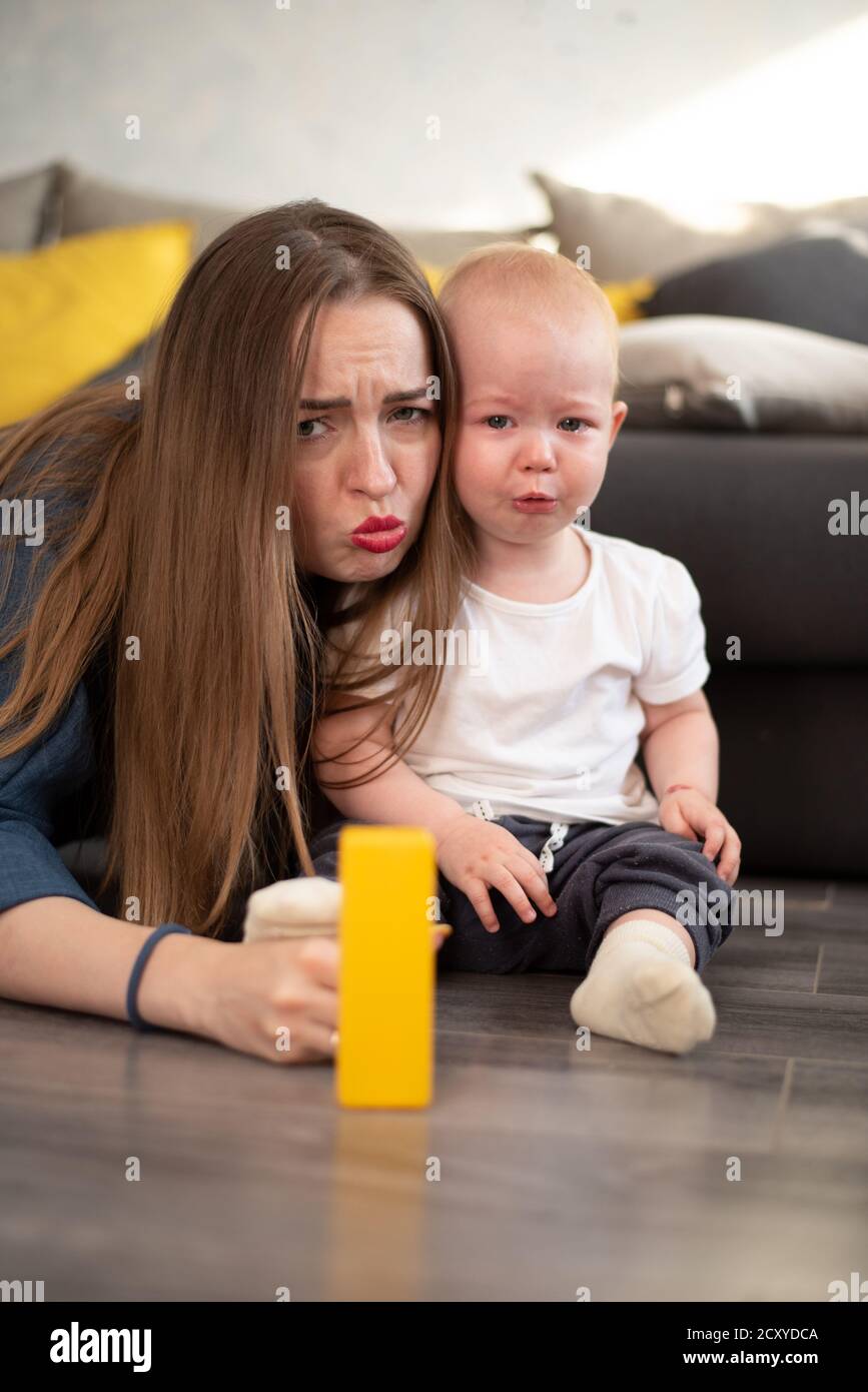 A young girl tries to comfort her little baby who is crying Stock Photo ...