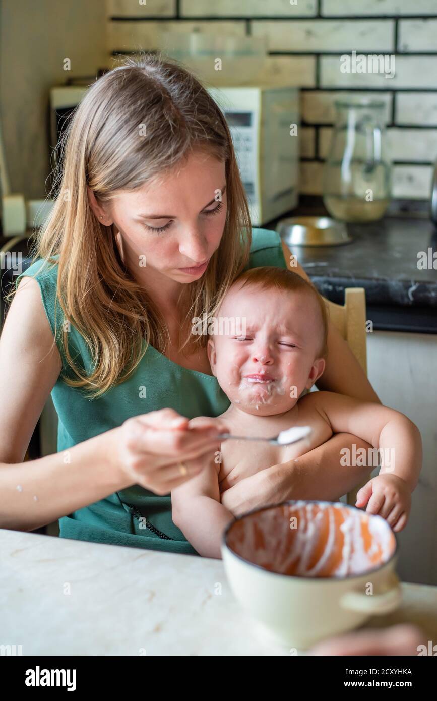 The child cries and refuses to eat milk porridge Stock Photo - Alamy
