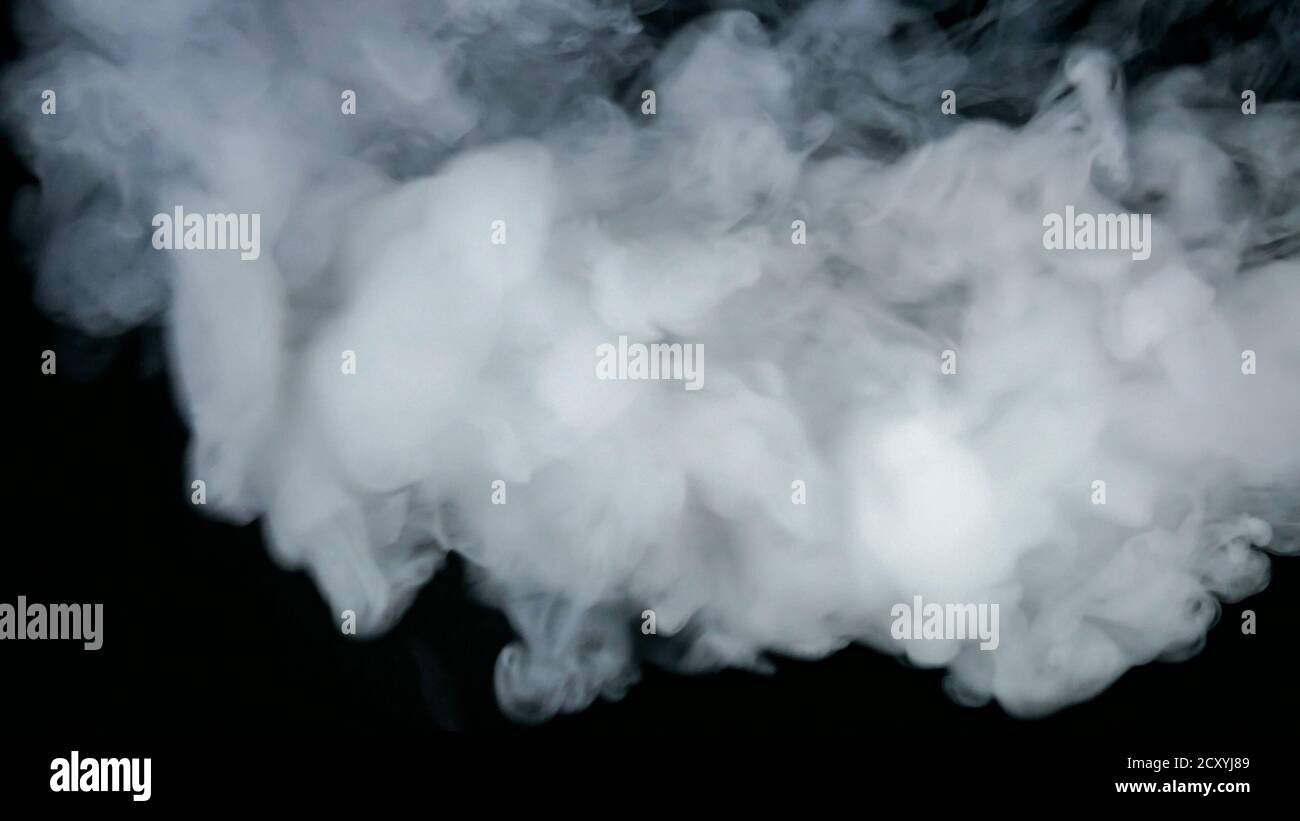 Dense smoke on black background captured in motion Stock Photo - Alamy