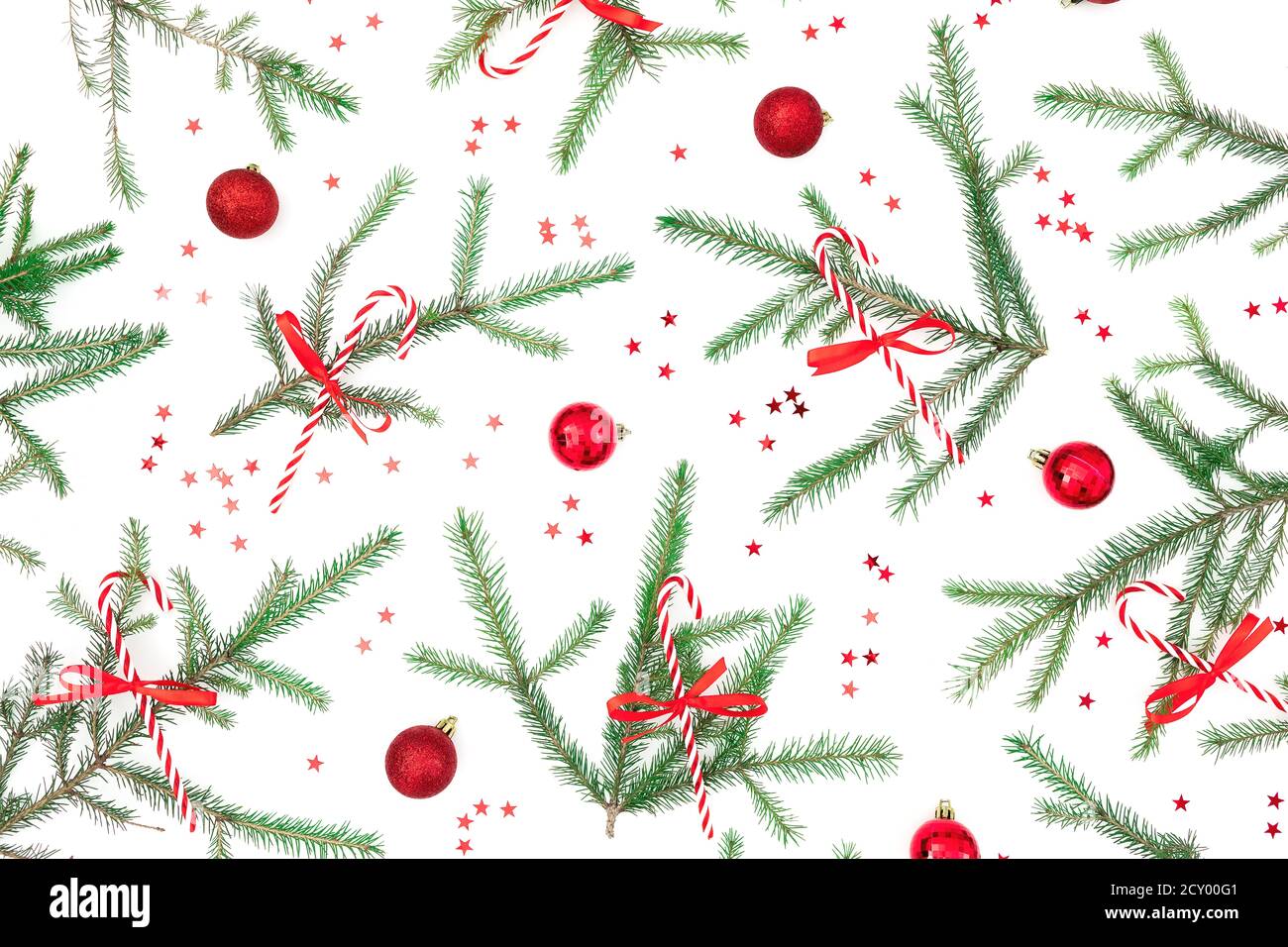Christmas pattern of fir tree branches and red decoration with candy ...