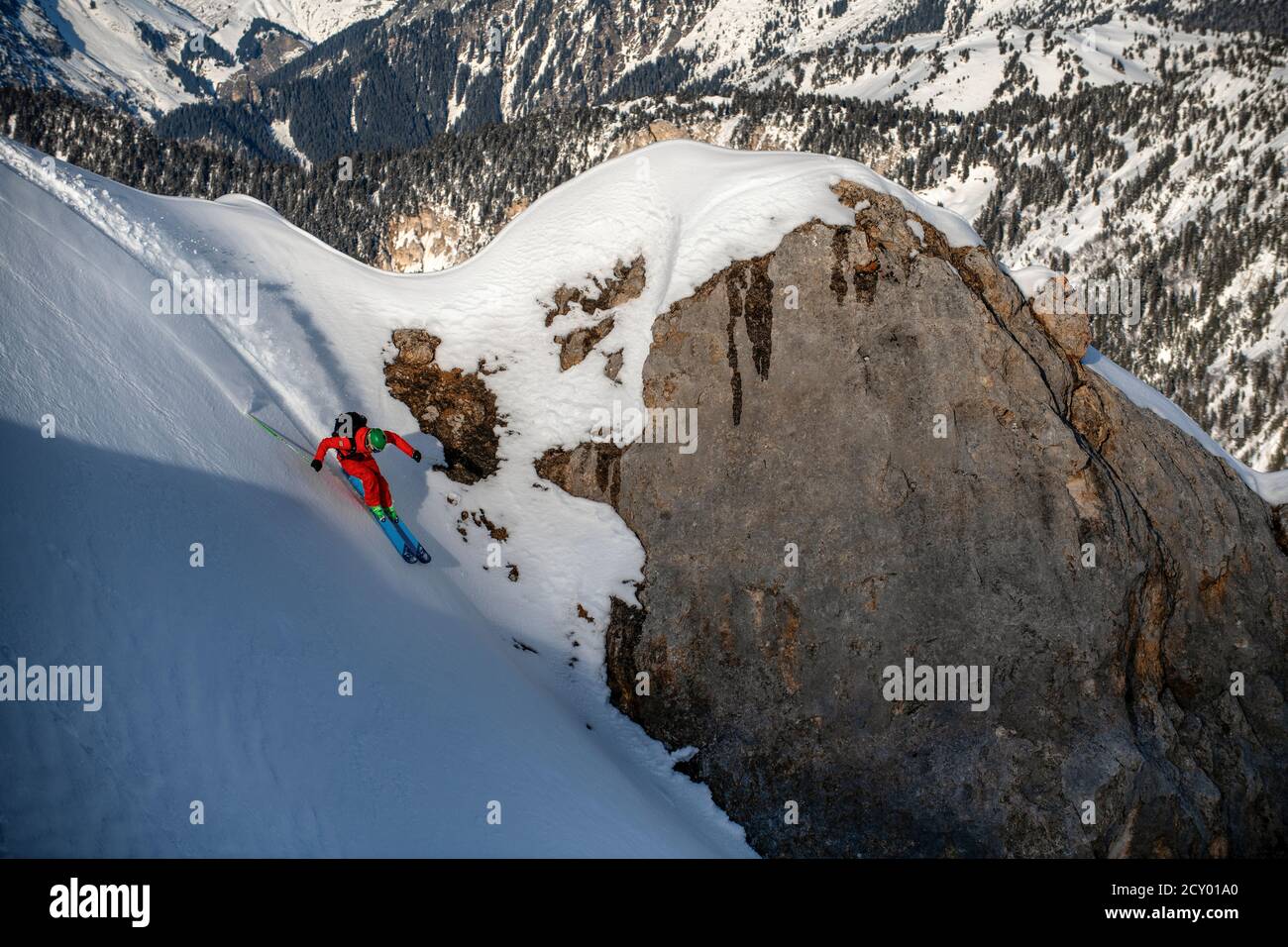 A male skier skiing off-piste in the French Alpine resort of Courchevel ...