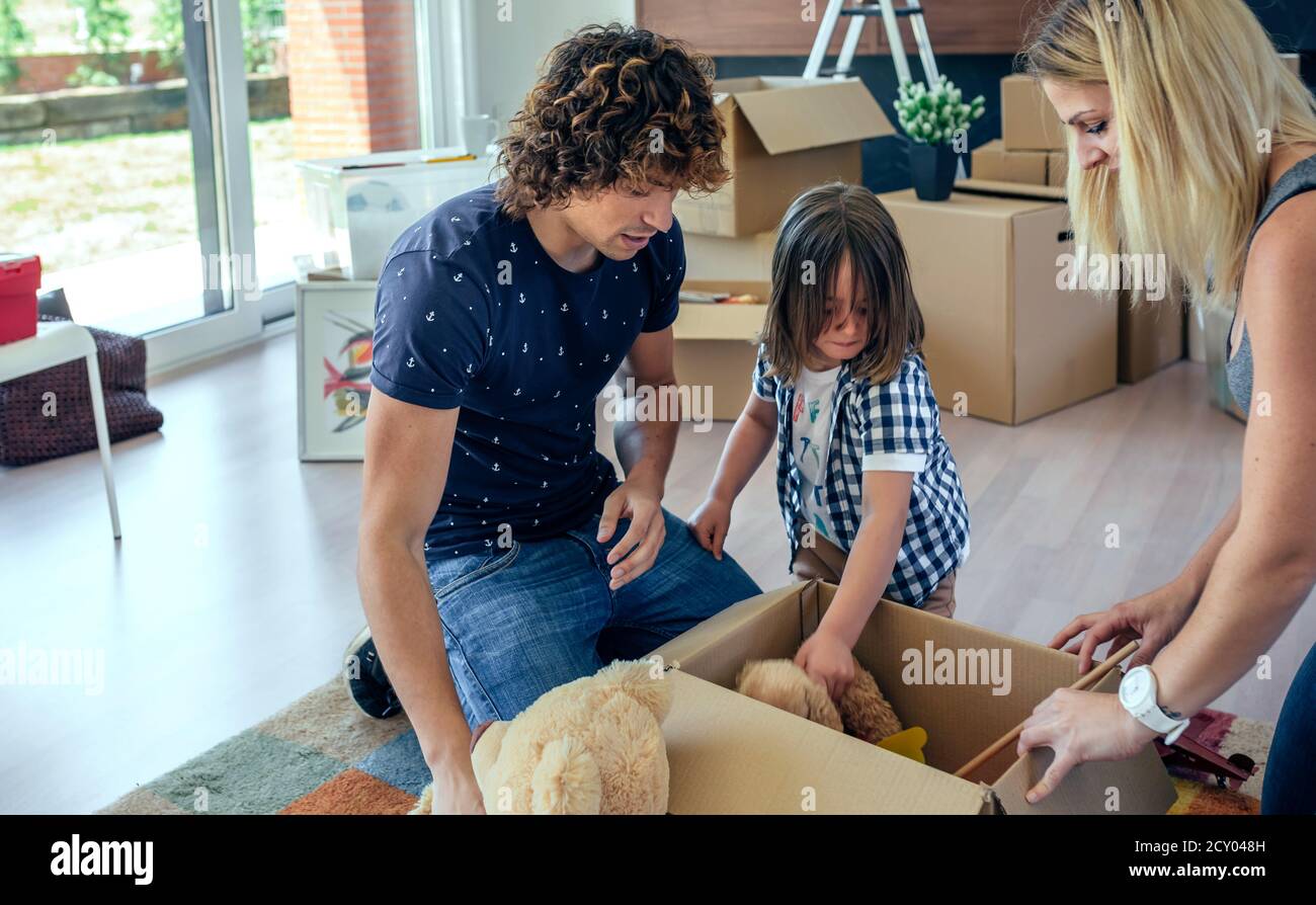 Family preparing moving toy box Stock Photo - Alamy