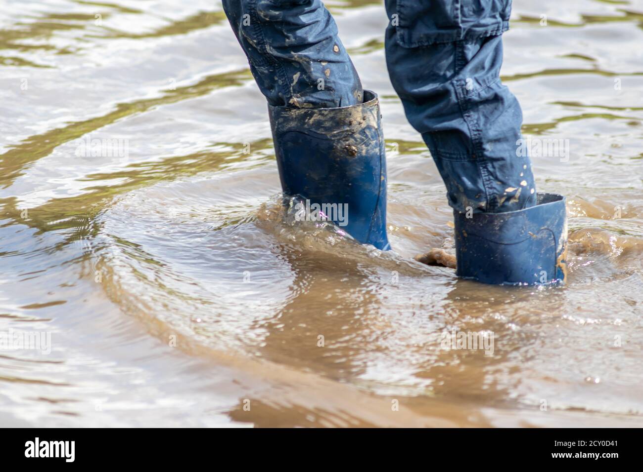 Woman wading through flood river hi-res stock photography and images ...