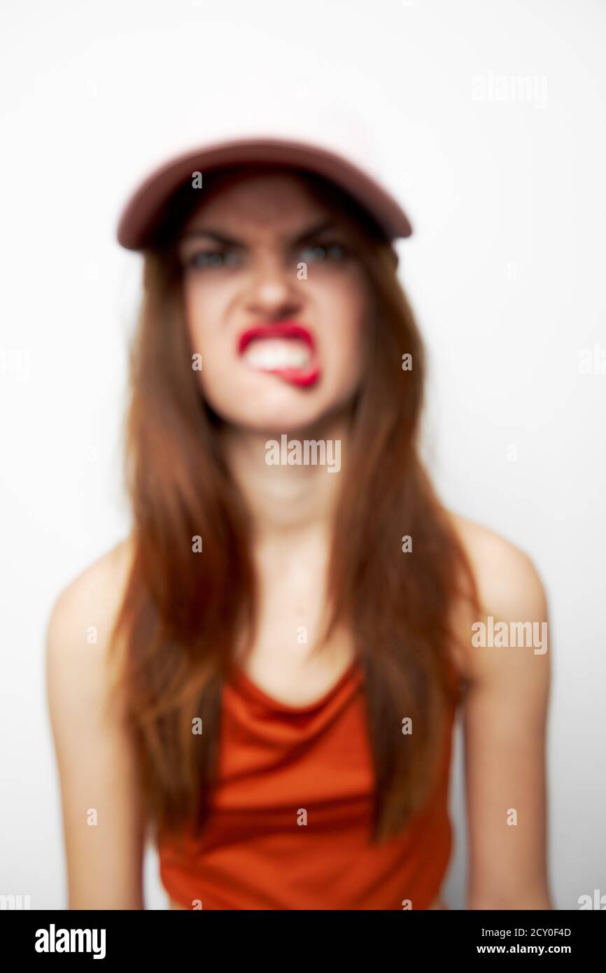 Portrait of a woman in a cap cheeky look model orange dress Stock Photo ...