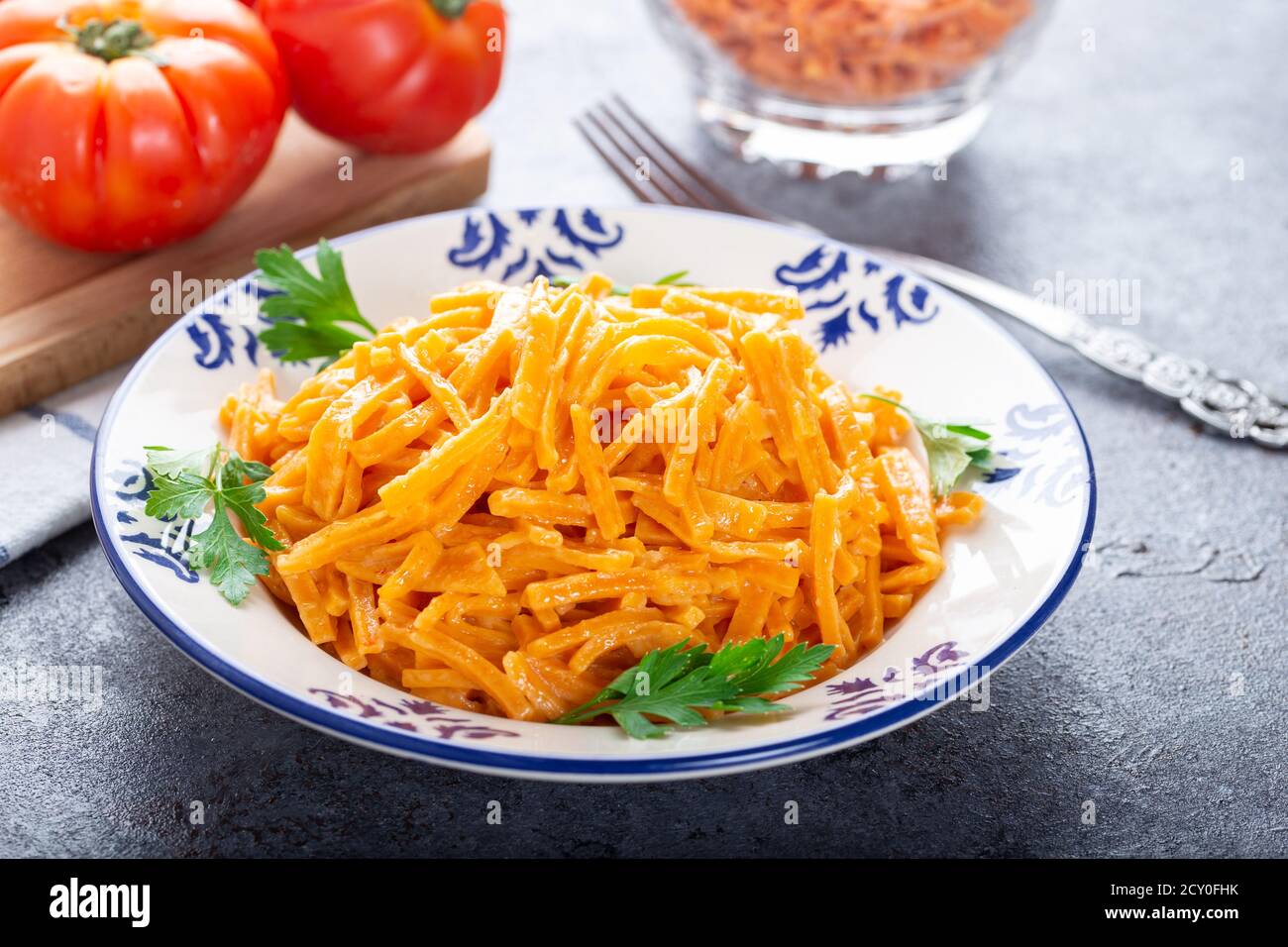Red colored homemade traditional tomato pasta or noodles Stock Photo ...