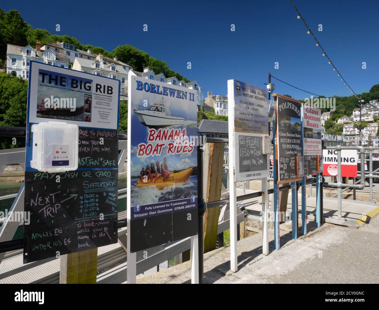 Boat trips advertising signs at Looe harbour, Cornwall Stock Photo - Alamy