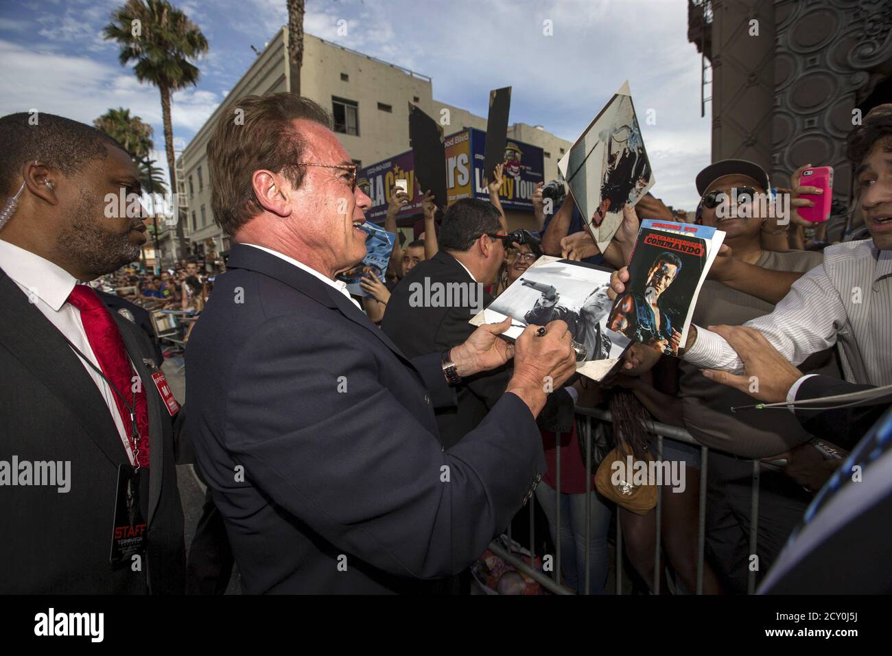 Cast member Arnold Schwarzenegger signs autographs at the premiere of ...