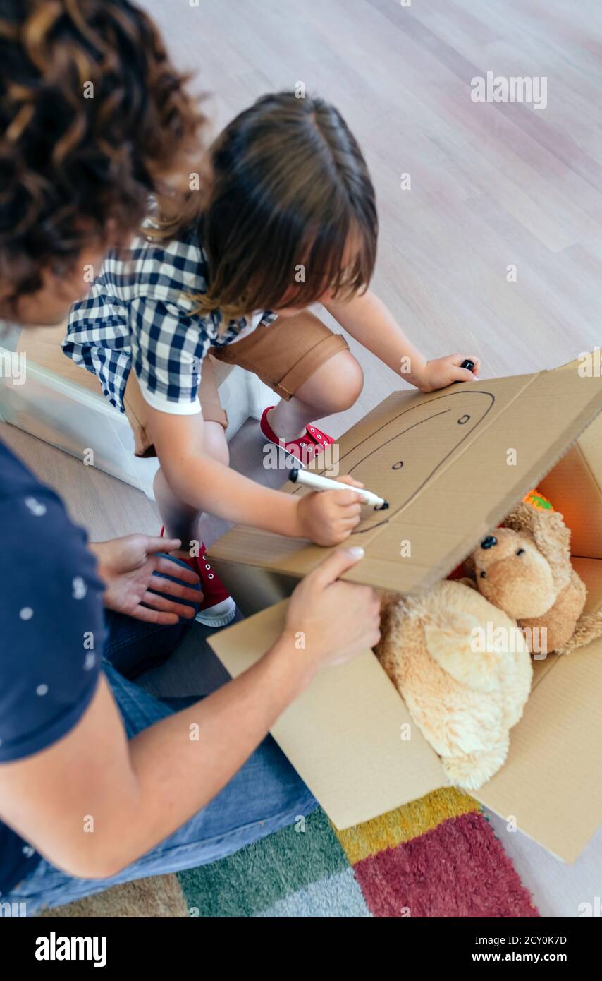 Boy drawing in a moving box Stock Photo - Alamy