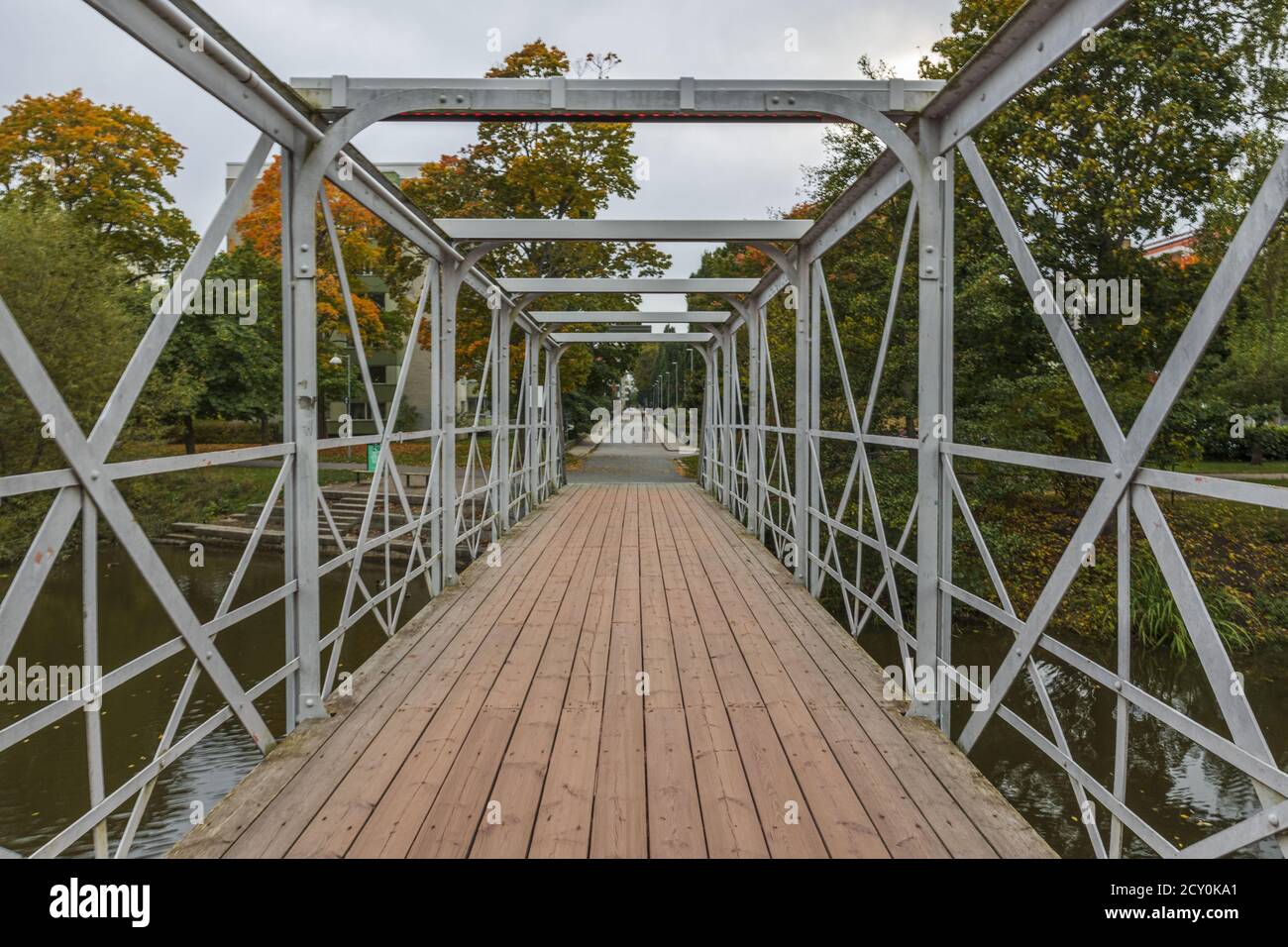 Beautiful autumn city landscape view. Metal bridge over river water on ...