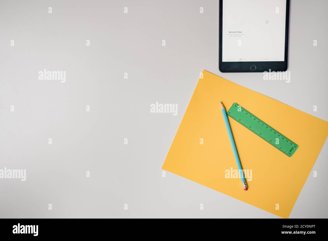 virtual learning tablet and school supplies on plain white background ...