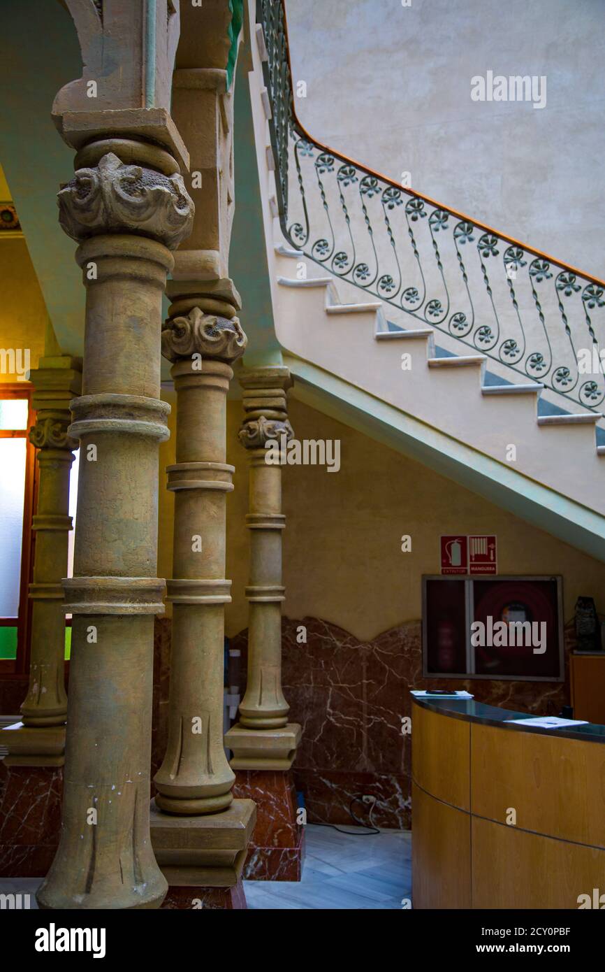 Stone columns in building interior with ornate stairs Stock Photo - Alamy