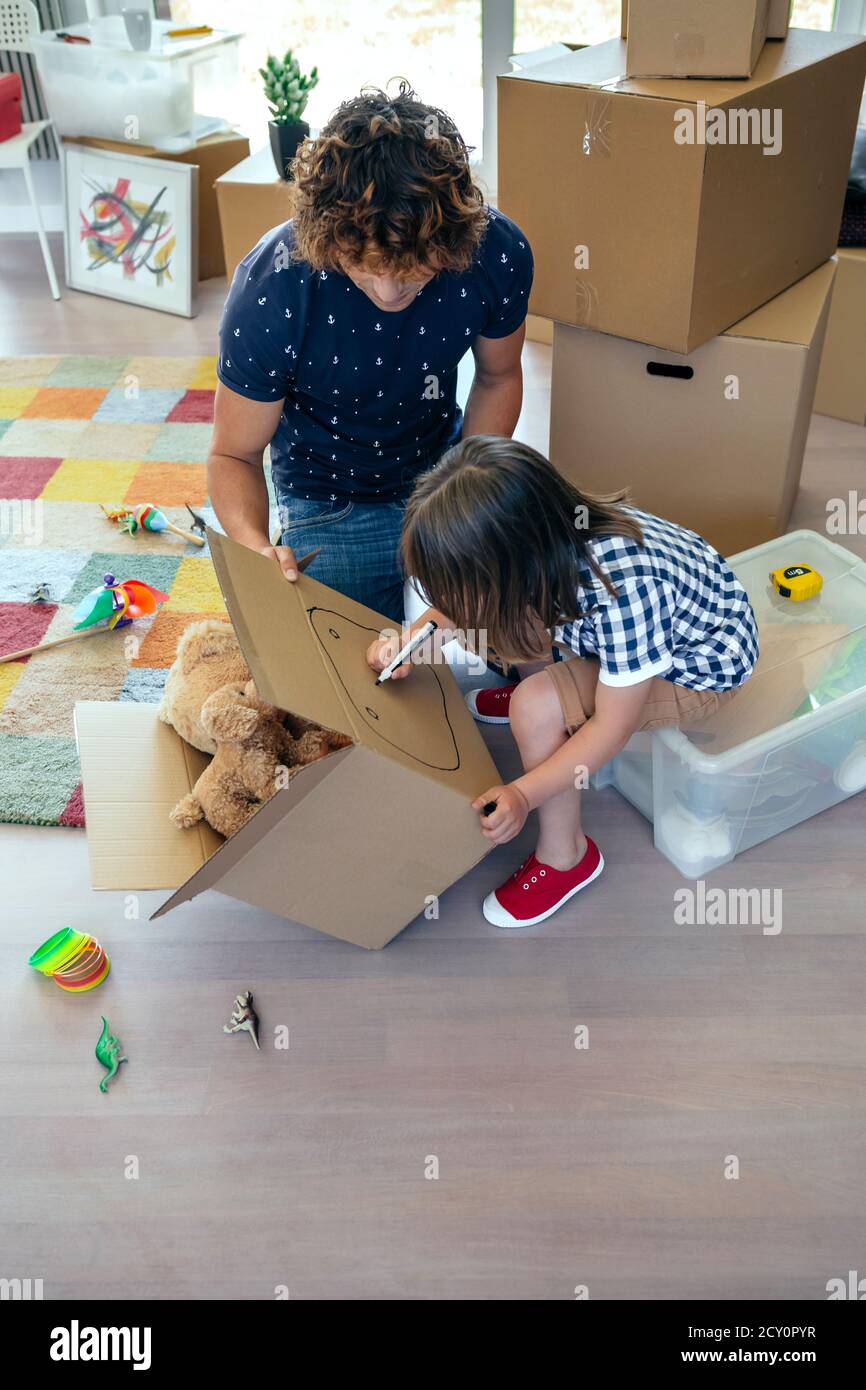 Boy drawing in a moving box Stock Photo - Alamy