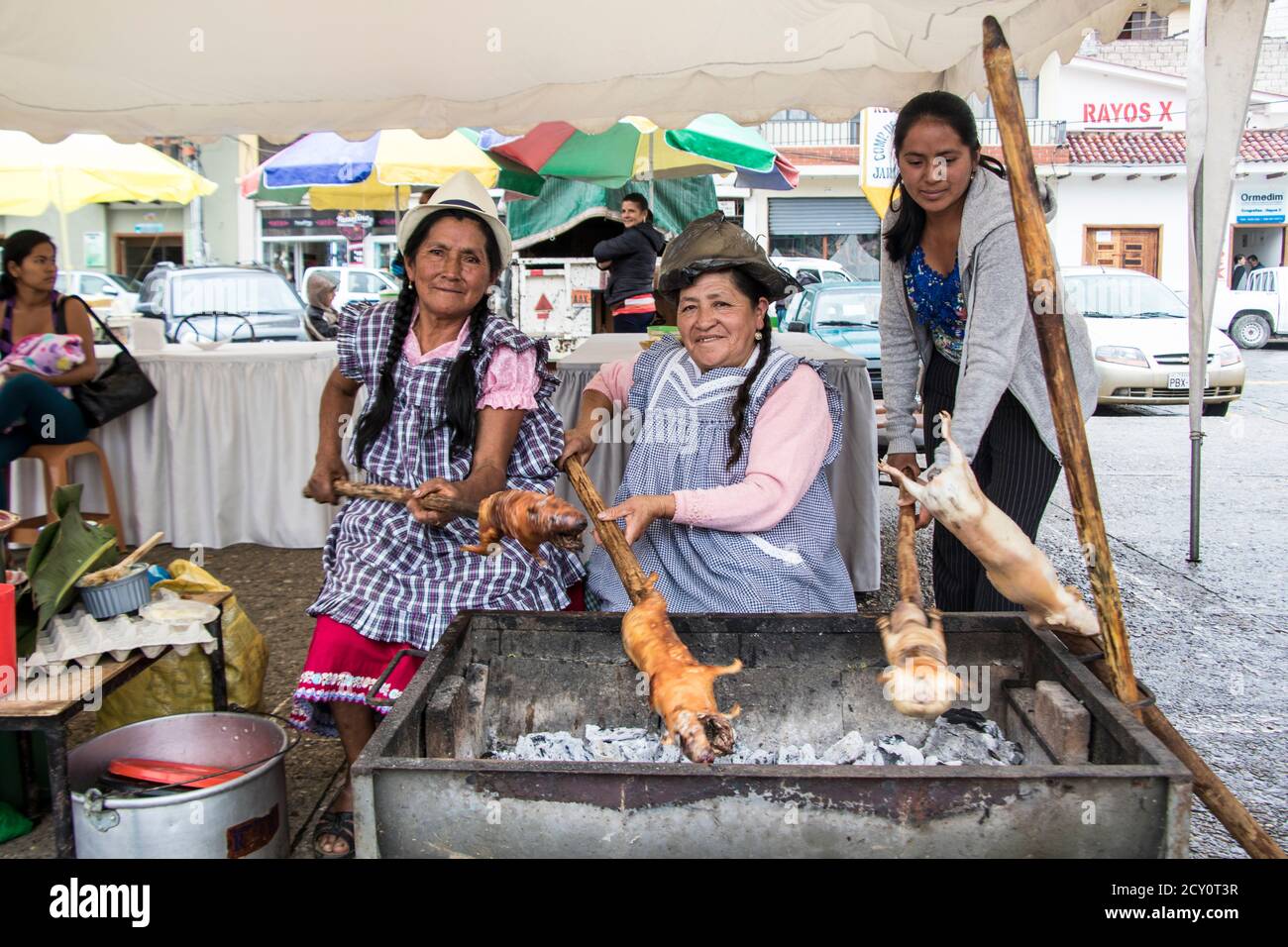 Cuenca, Ecuador - March 13, 2016 - Three women BBQ cuy for lunch at an ...
