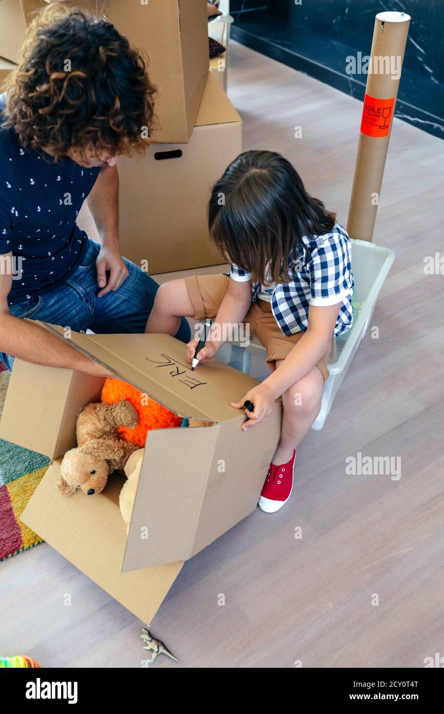 Boy writing in a moving box Stock Photo - Alamy