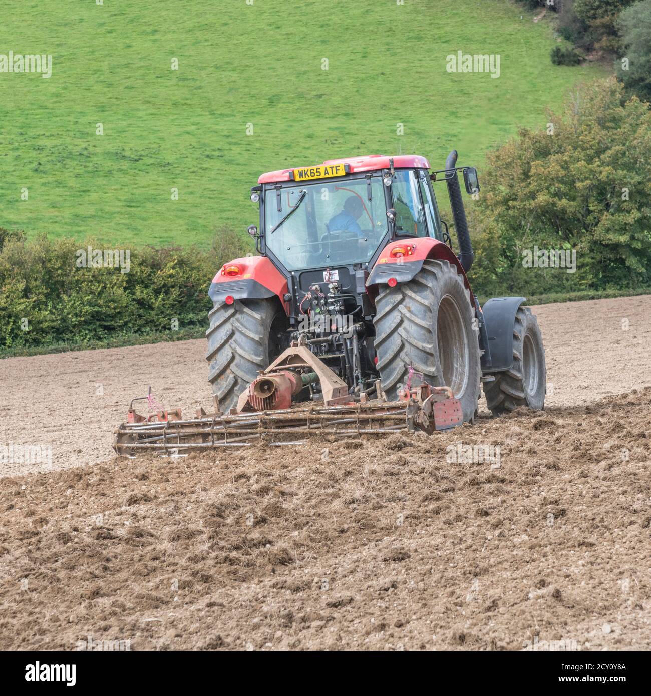 Red Czech Zetor tractor / Forterra 140 HSX tilling arable field with ...