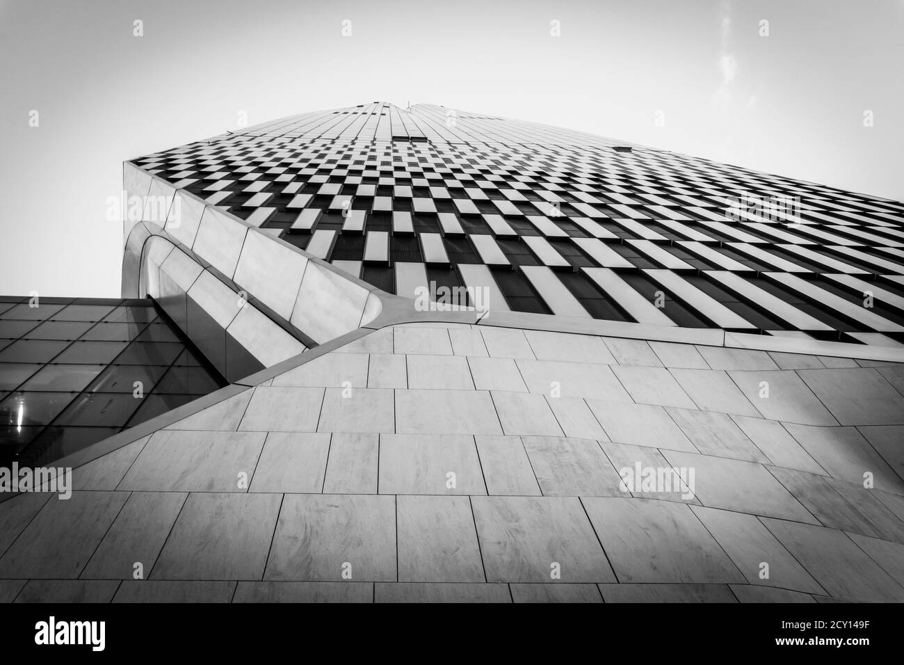 Black and white photo of a commercial building with sky. Up view in ...