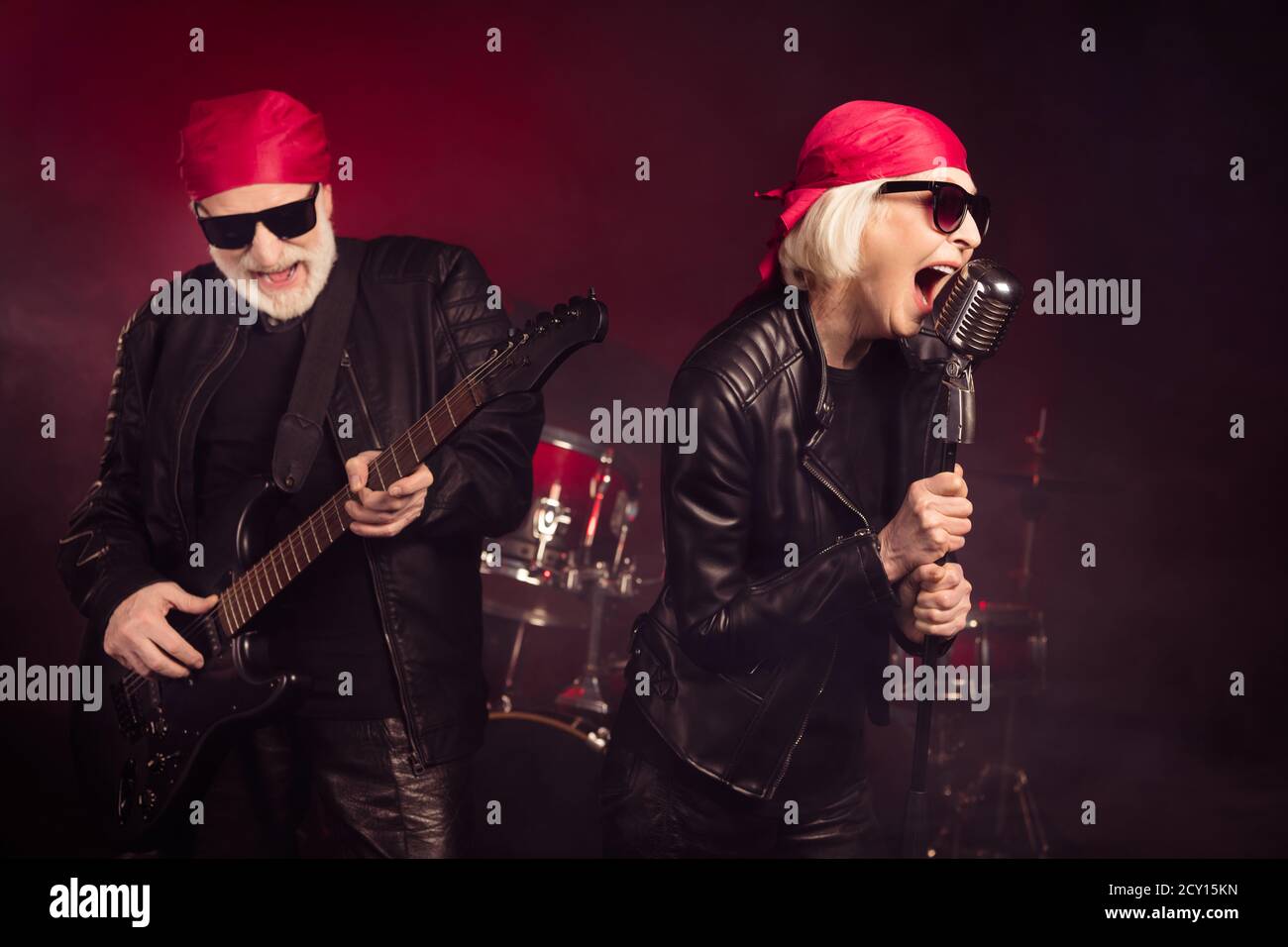 Photo of aged lady man popular old rock group family concert play solo ...