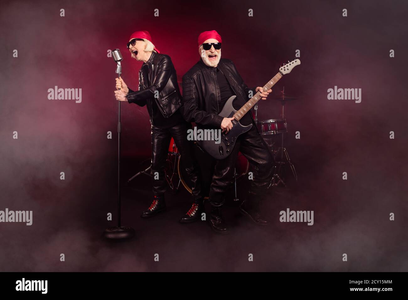 Photo of two aged lady man popular old rock group perform concert play ...