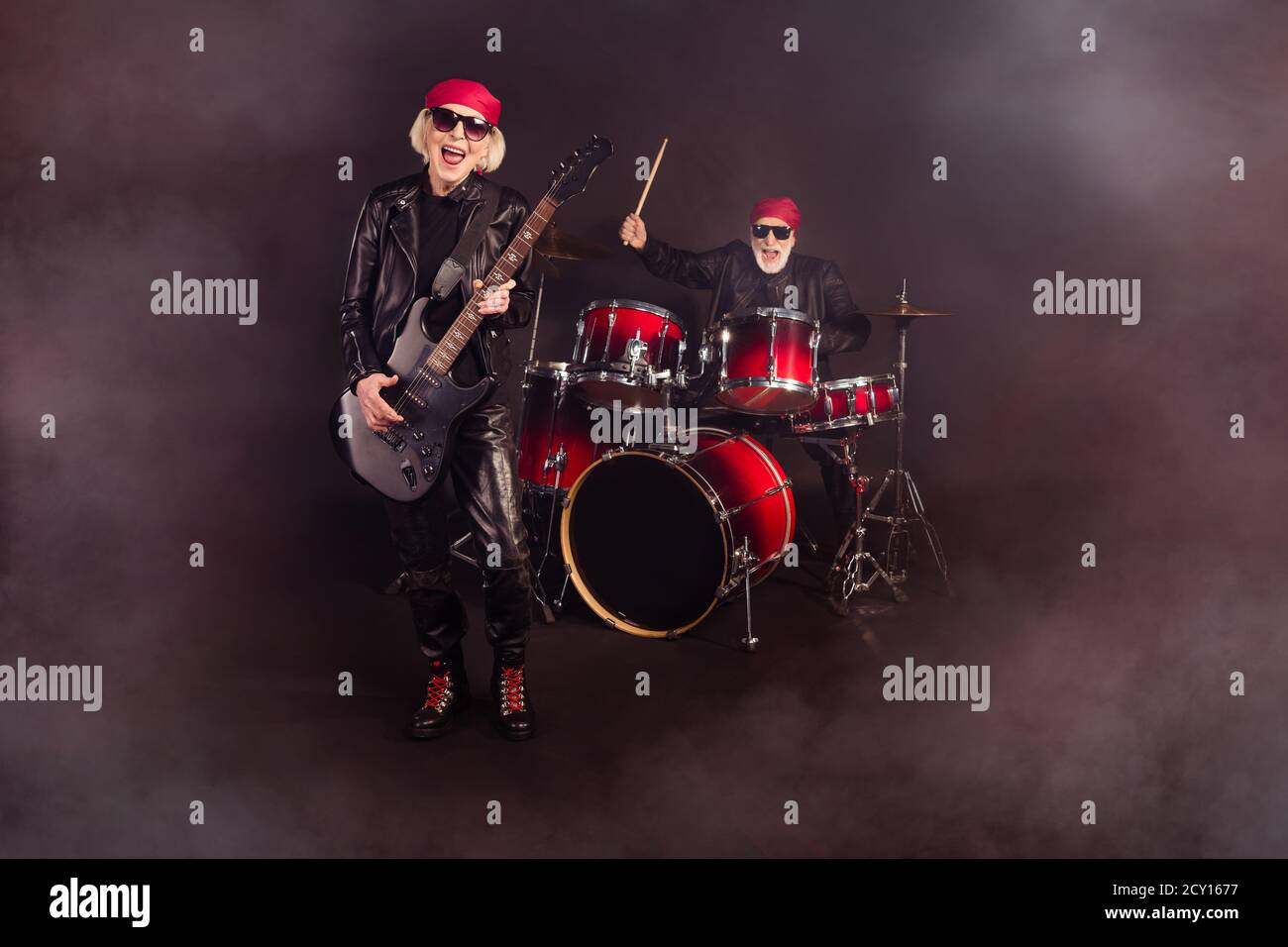 Full body photo of two aged lady man rock group perform concert play ...