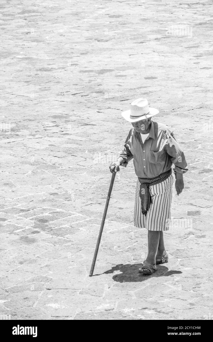 Black and white old man with hat walking with a cane Stock Photo - Alamy