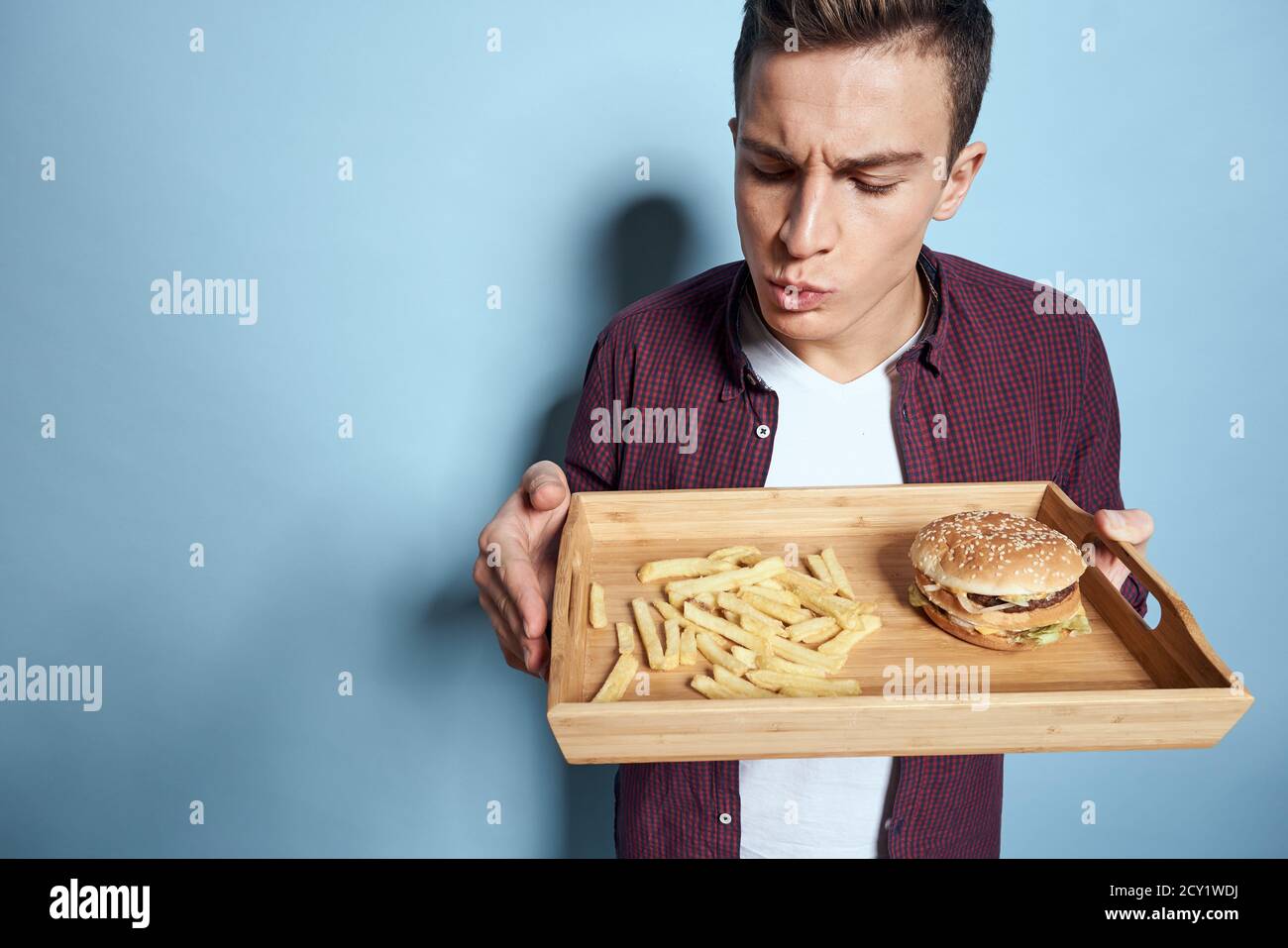 Man with wooden pallet fast food french fries hamburger hunger diet ...