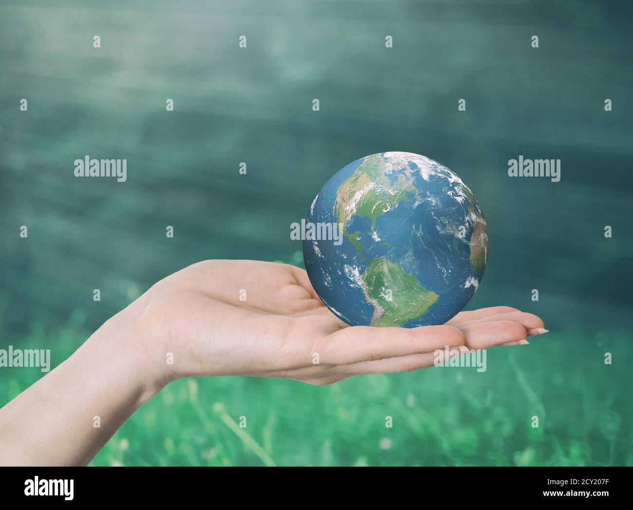 Hand Holding Earth In Lush Green Environment With Sunlight - Caring For ...