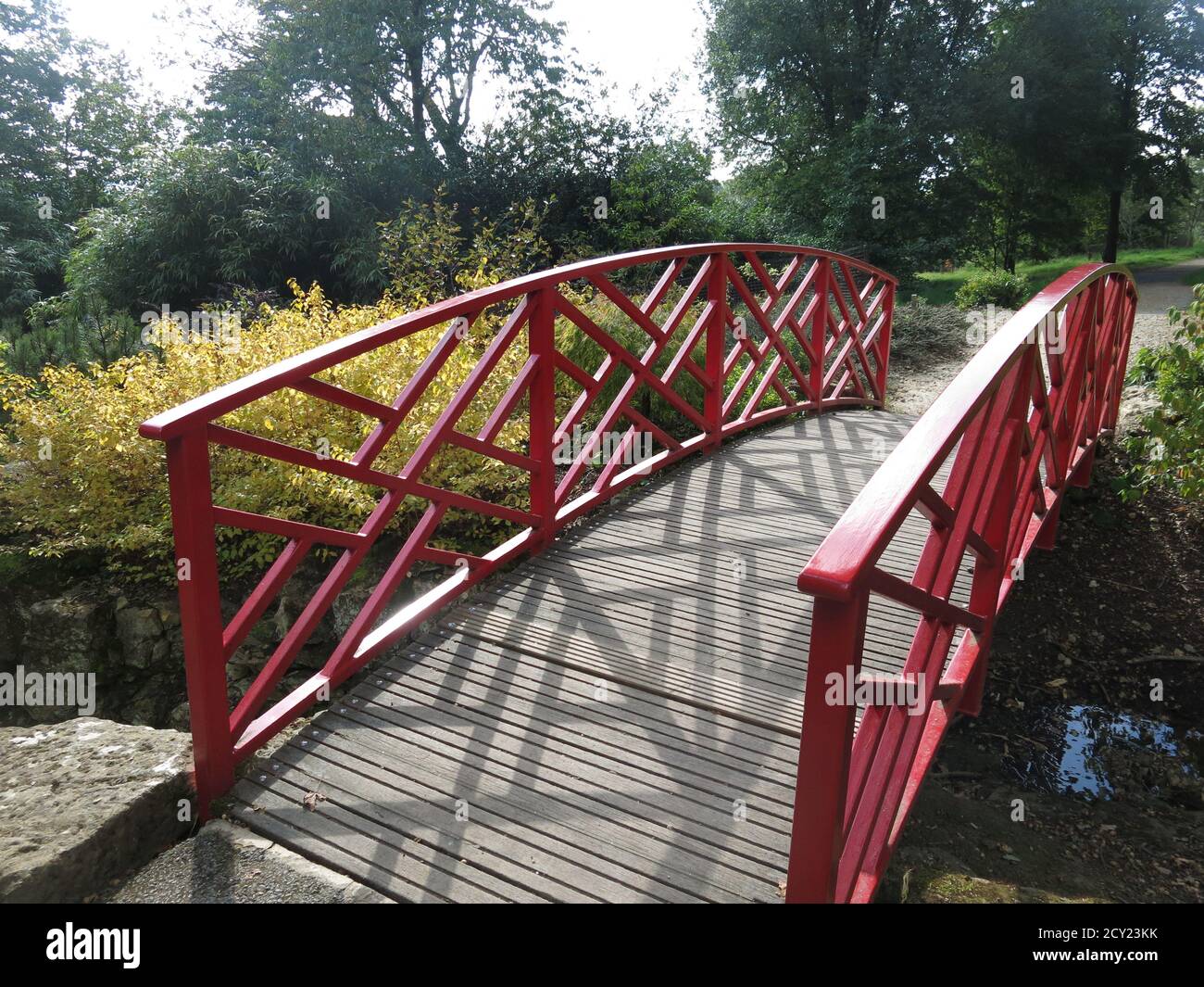 One of the arched, red painted, Japanese-style bridges at Batsford ...