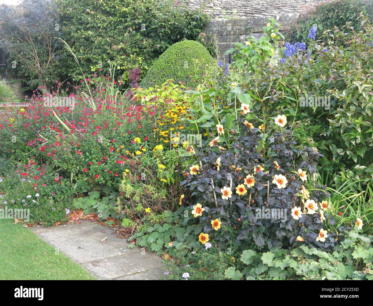 A richly planted flower border in the gardens at Bourton House; an ...