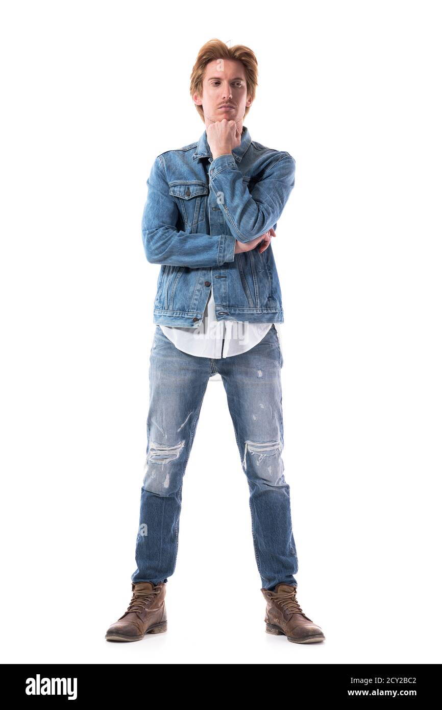 Serious handsome man with hand on chin looking away thinking and ...