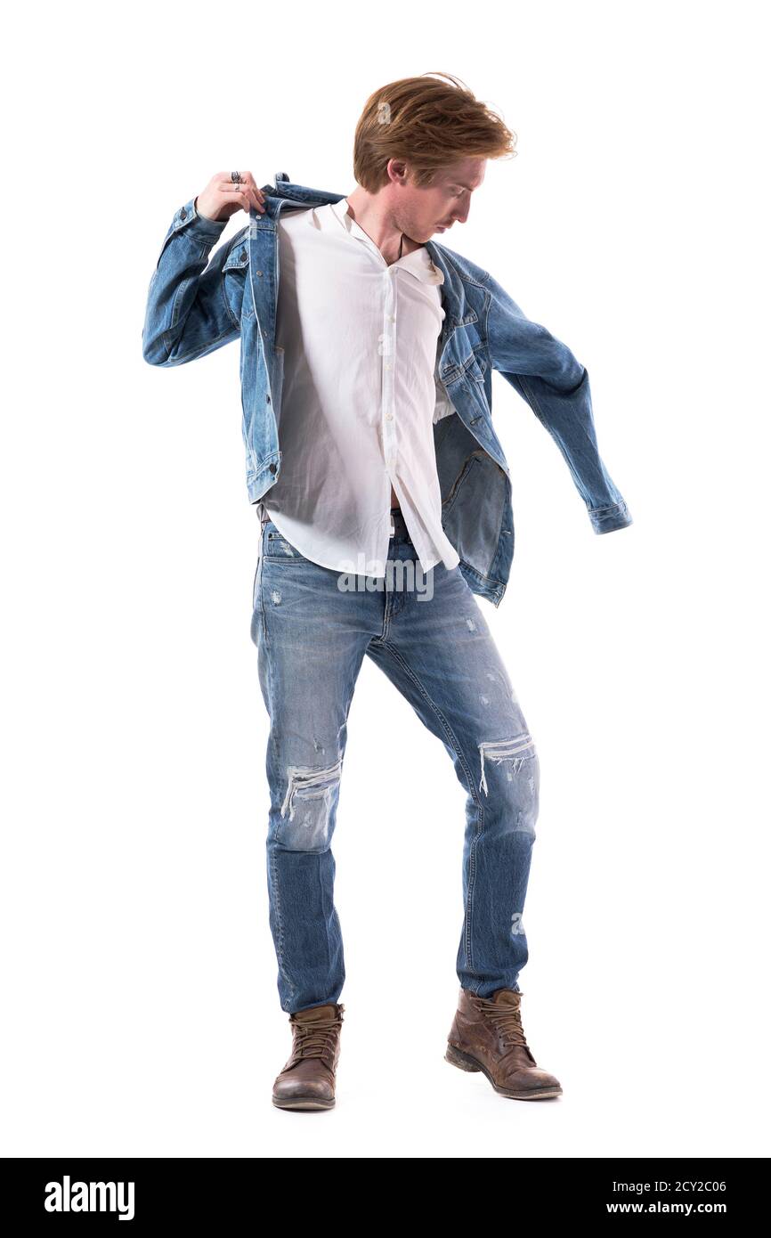 Handsome red hair man getting dressed trying on new jacket while ...