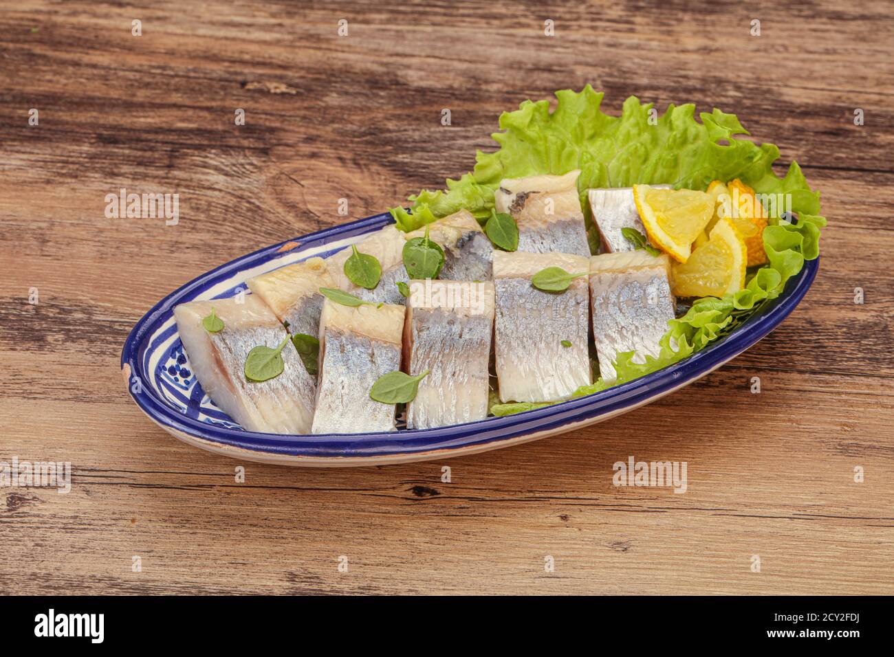 Marinated Herring fillet with sliced lemon Stock Photo - Alamy