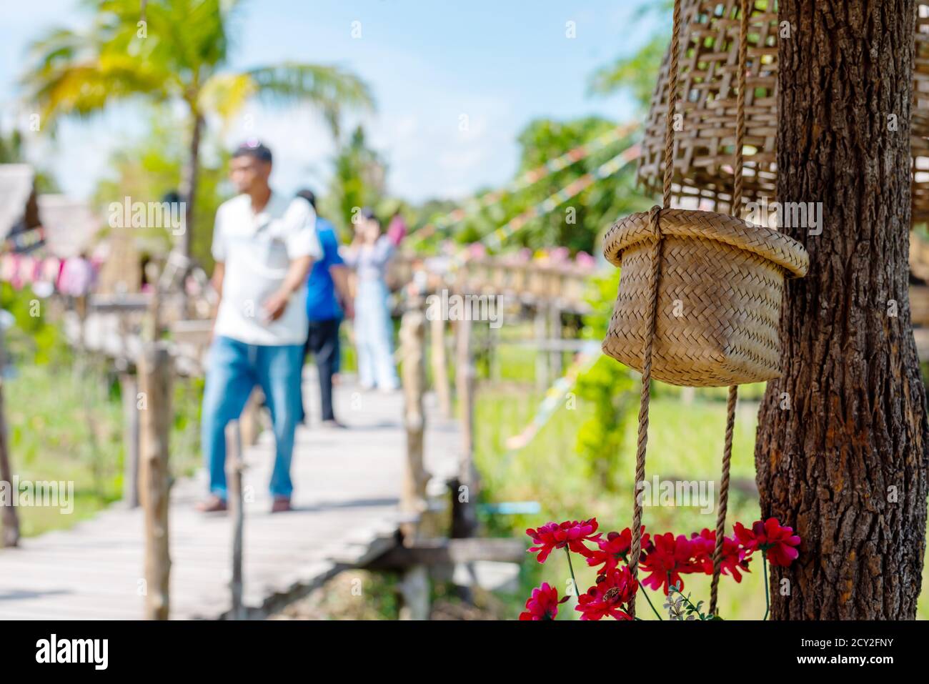 Baskets hanging The background is blurred and people walk around to ...