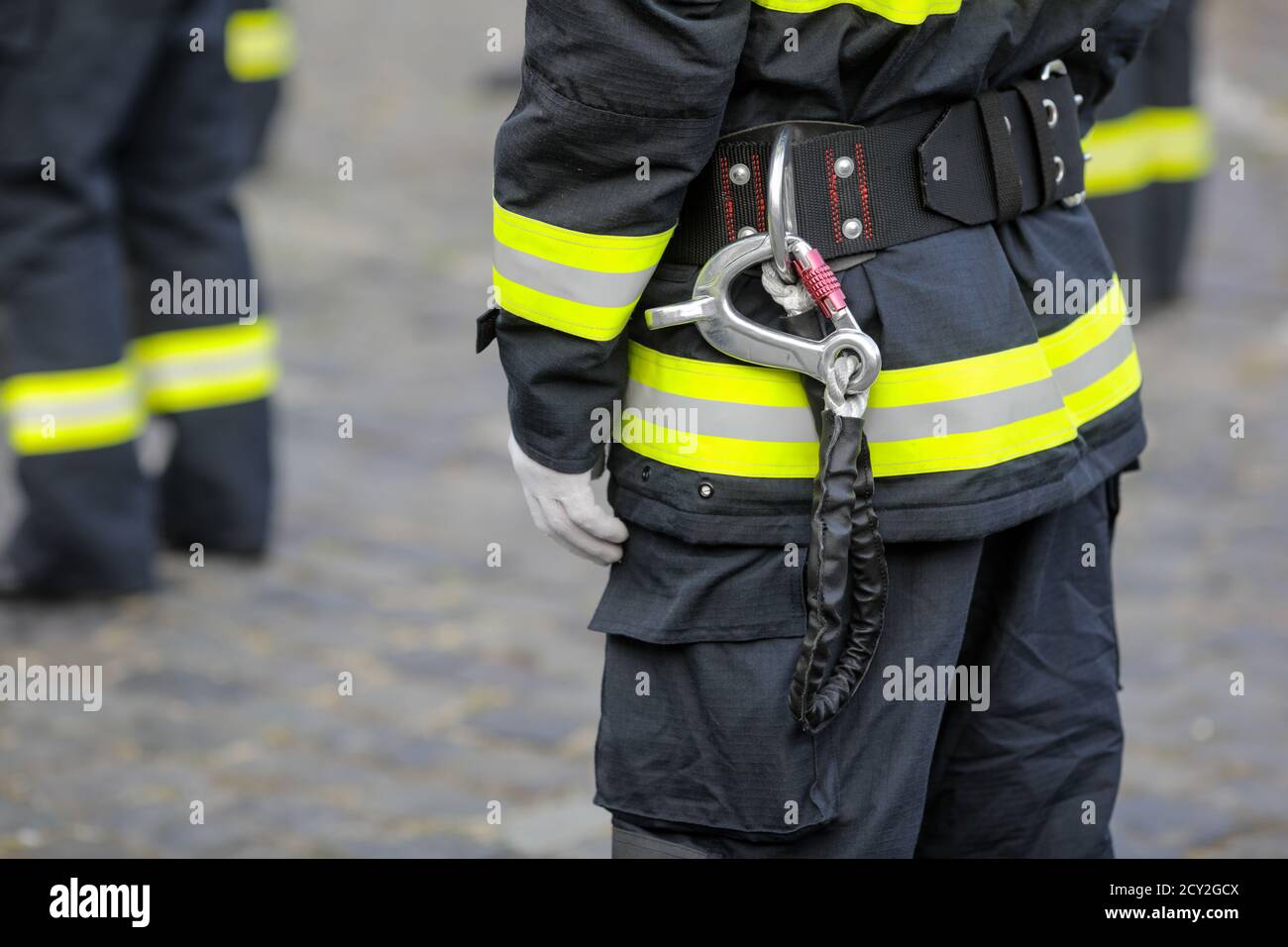 Details with the carabiner and harness of a firefighter Stock Photo - Alamy